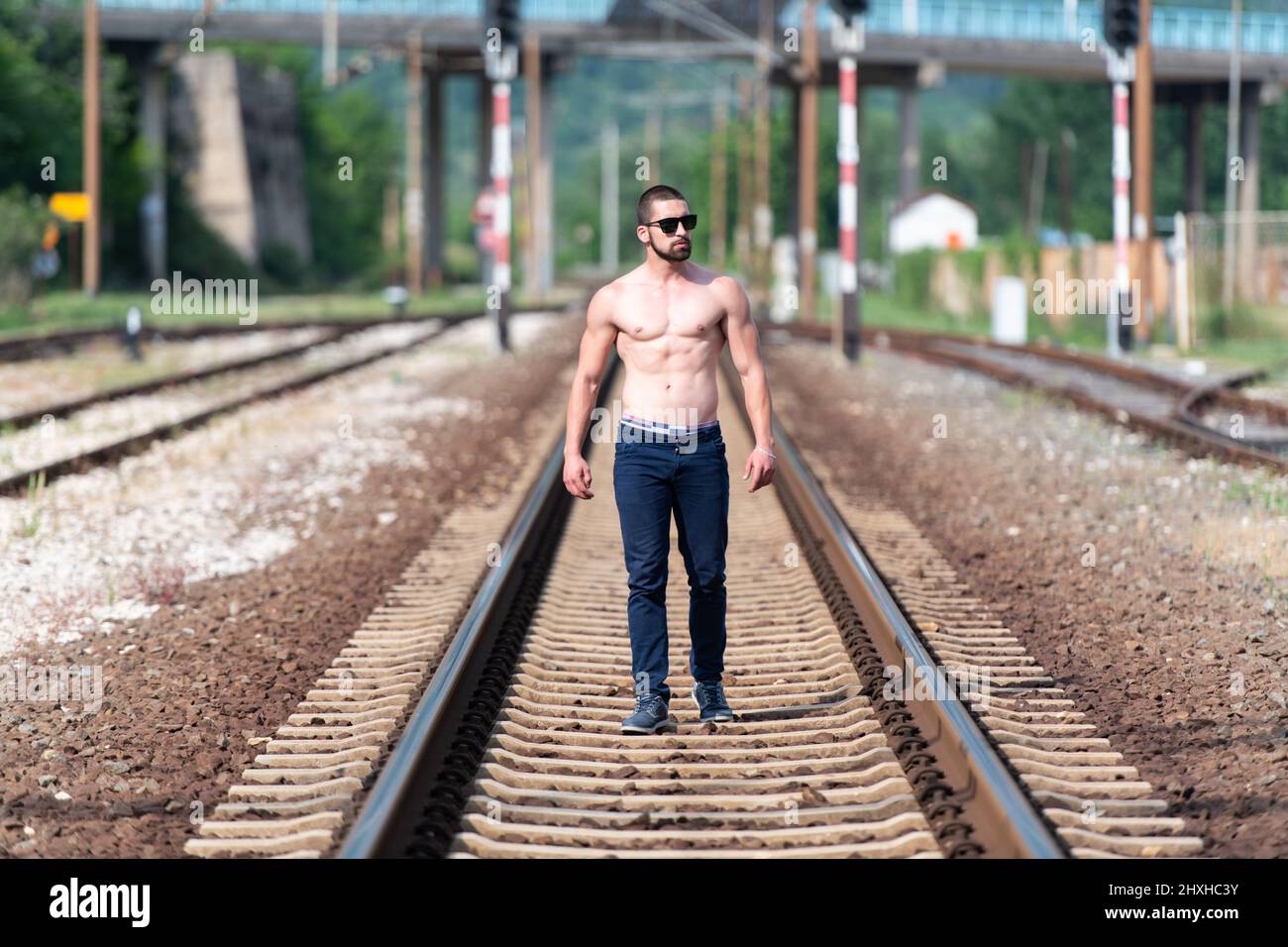 Handsome Beard Man Standing Strong and Posing Outdoors at Railroad From ...