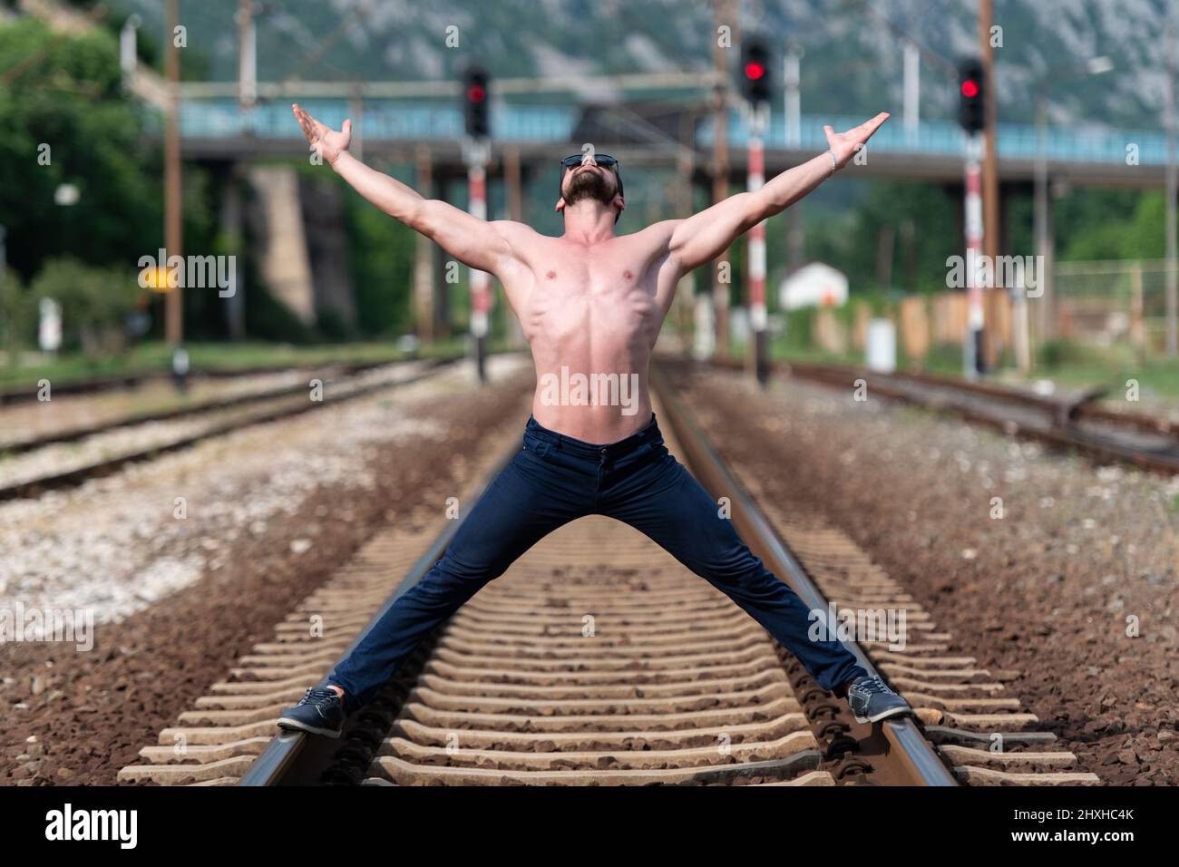 Handsome Beard Man Standing Strong and Posing Outdoors at Railroad From ...
