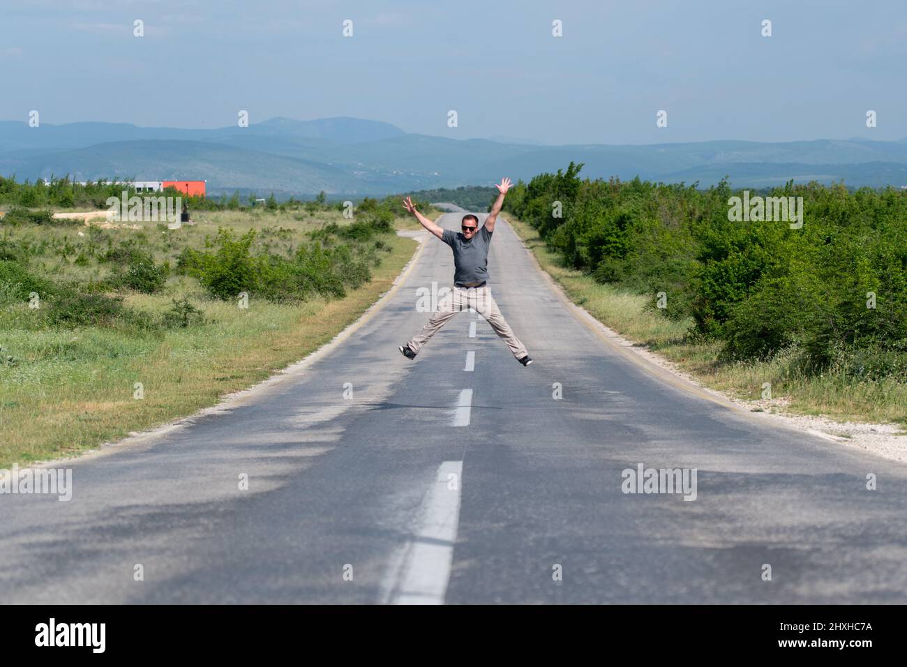 Handsome Man Jumping at Street Highway and Having Fun Outdoors Stock ...