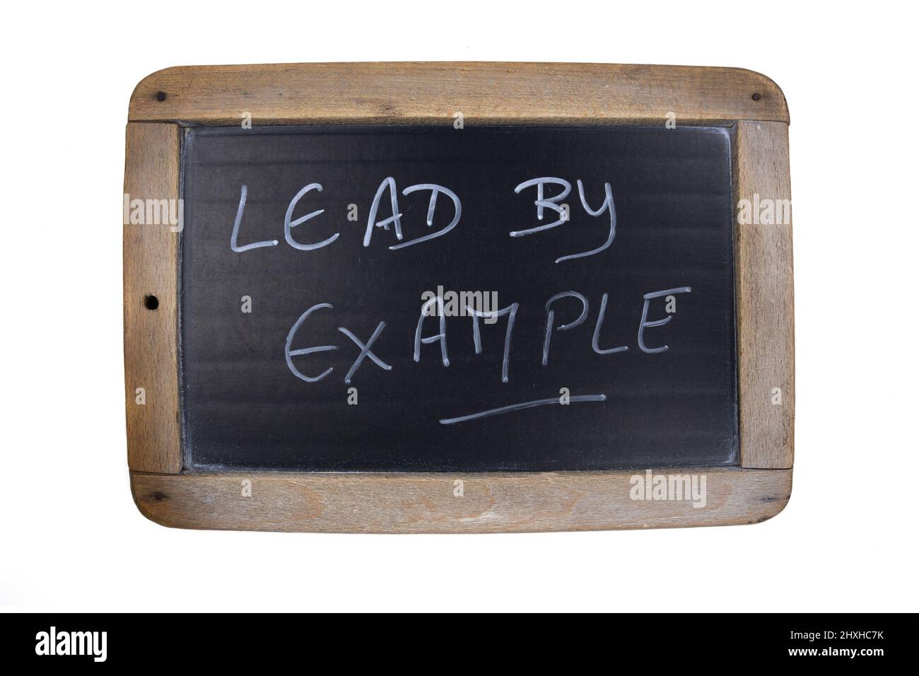 inscription in english lead by example isolated on a slate Stock Photo ...