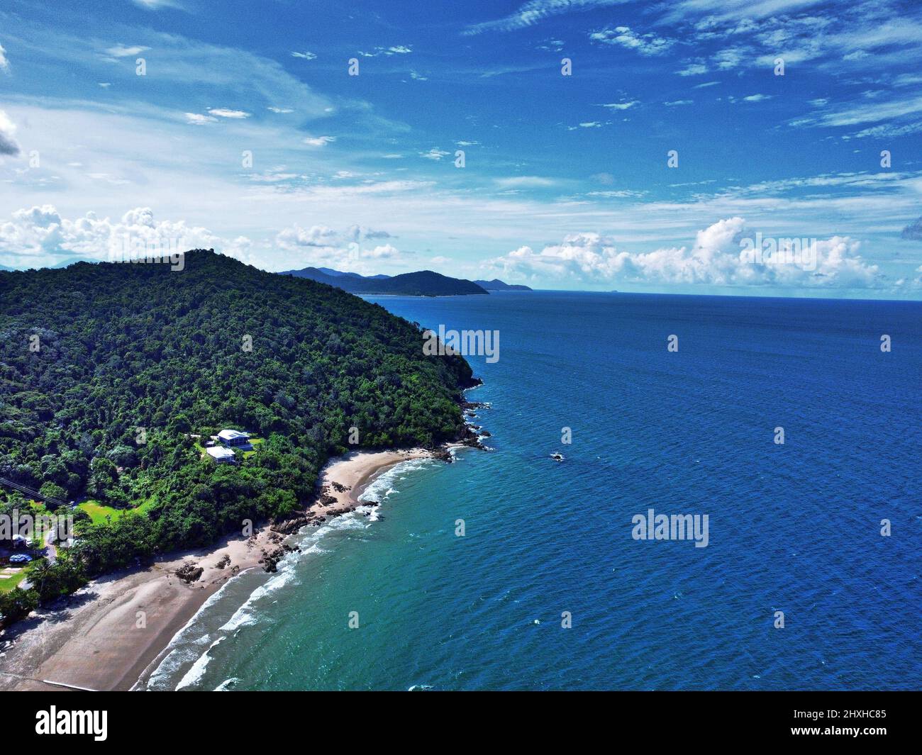 Aerial view of Etty bay ocean and mountains with blue sky Stock Photo ...