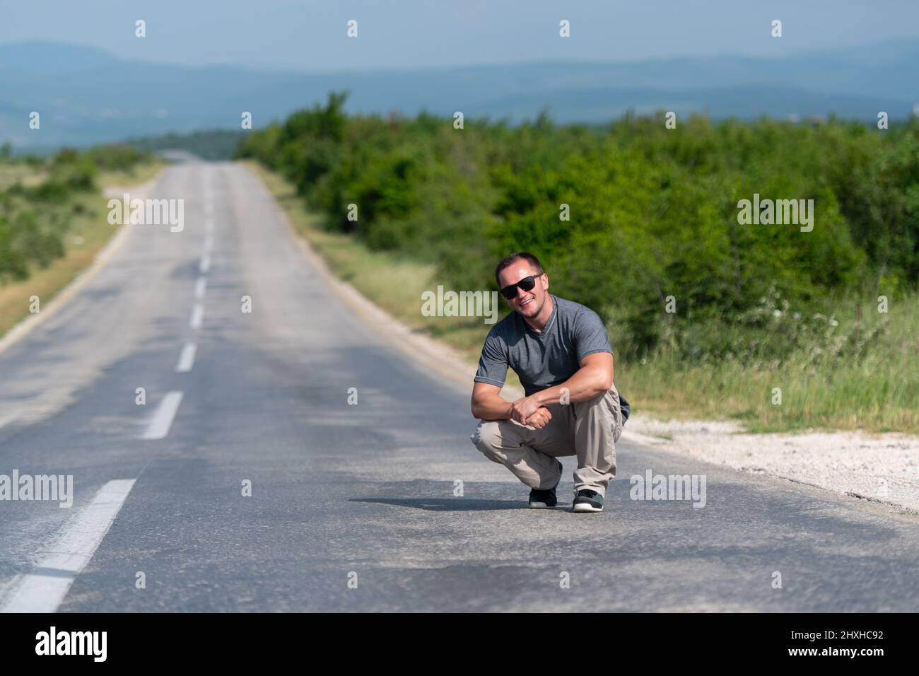Handsome Man Crouching Strong and Posing Outdoors at Street Highway ...