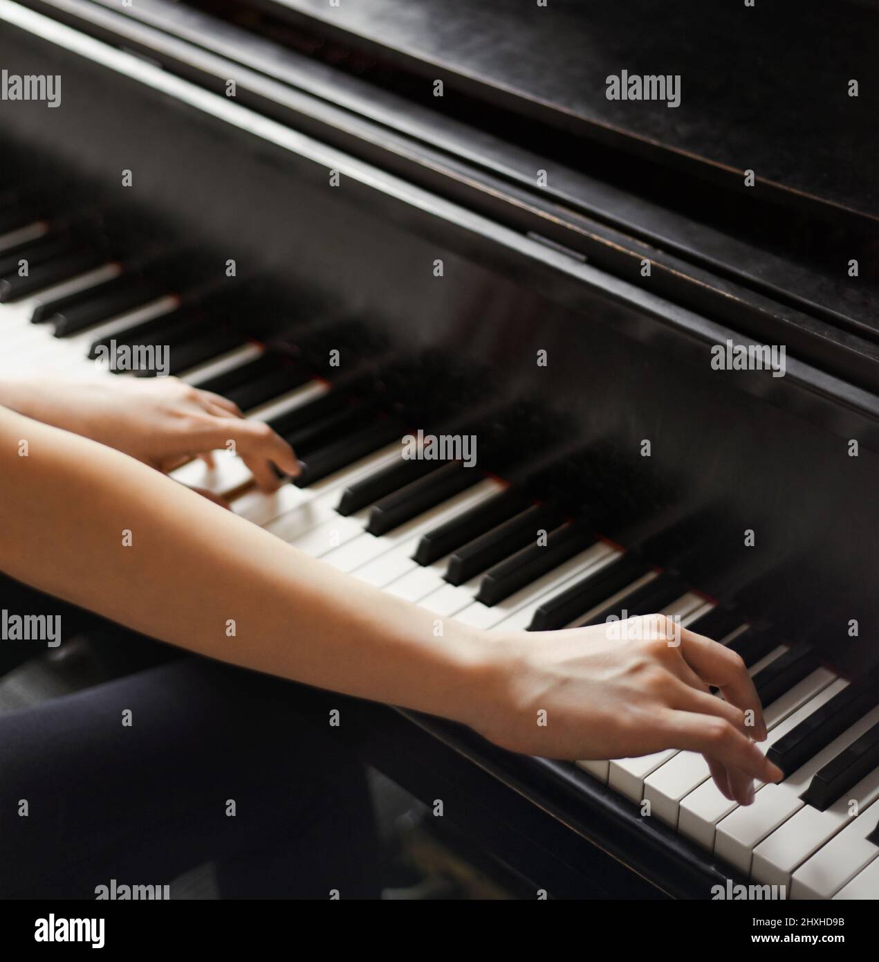 Reaching for the right notes. Cropped shot of hands on piano keys Stock ...
