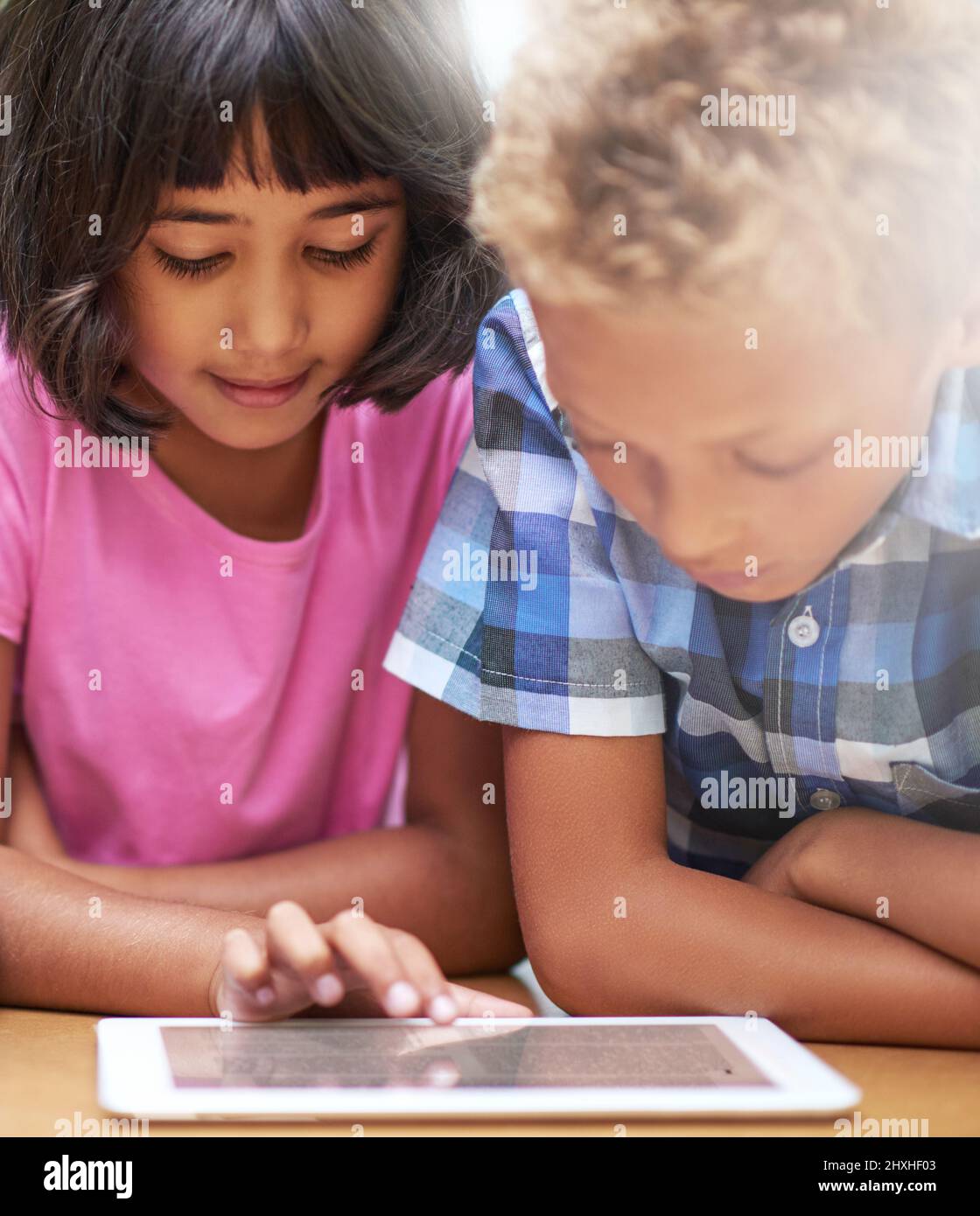 Wireless discoveries. Shot of elementary school children using a ...