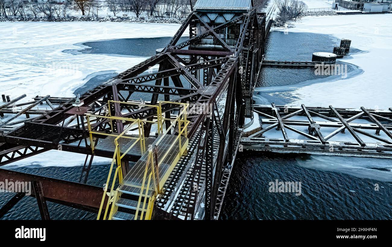Its early in the morning with snow falling over the old rusty walkway ...