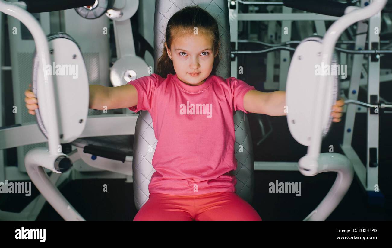 Fit Athletic Baby Girl Work out in Butterfly Pectoral Machine for Chest ...