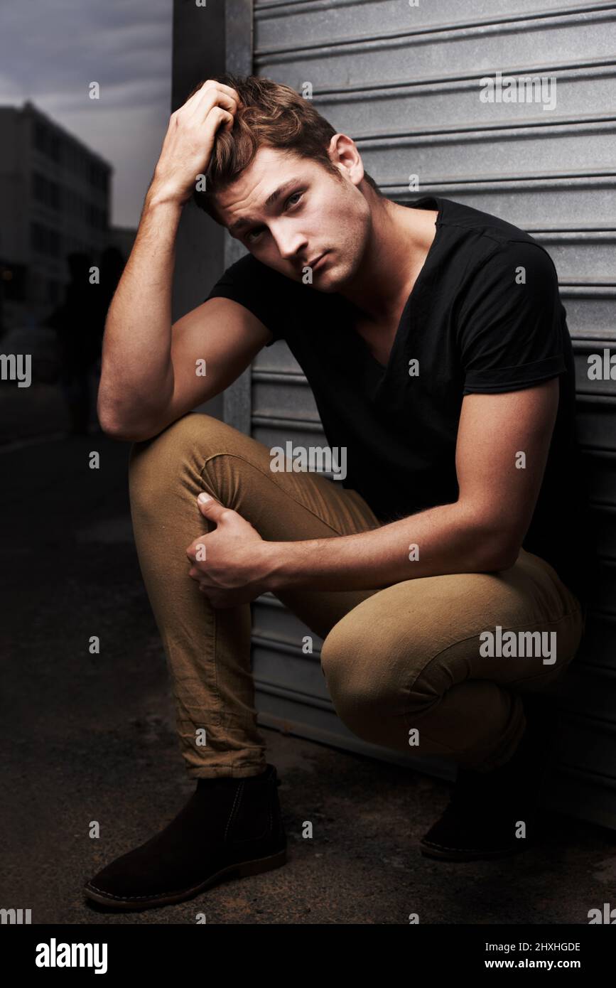 Looks and attitude. Shot of a thoughtful-looking young man running his ...