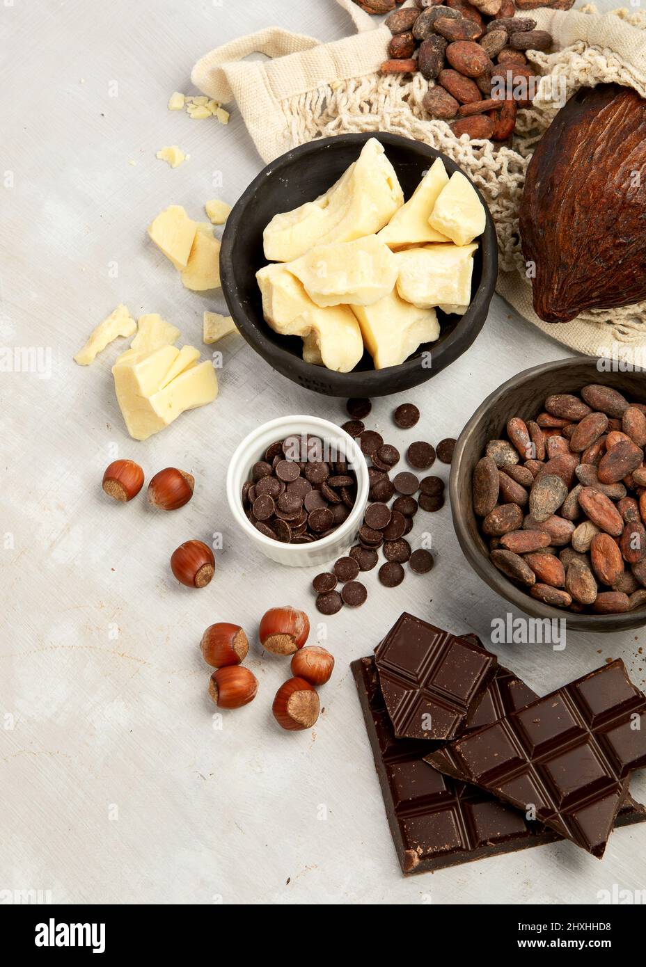 Cacao beans and powder, cacao butter and chopped chocolate on a white ...