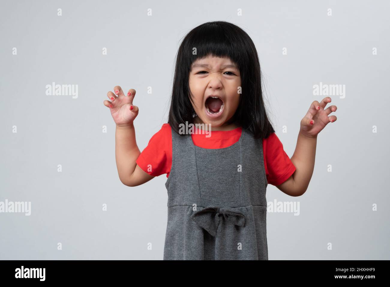 Portrait of Asian angry and sad little girl on white isolated ...