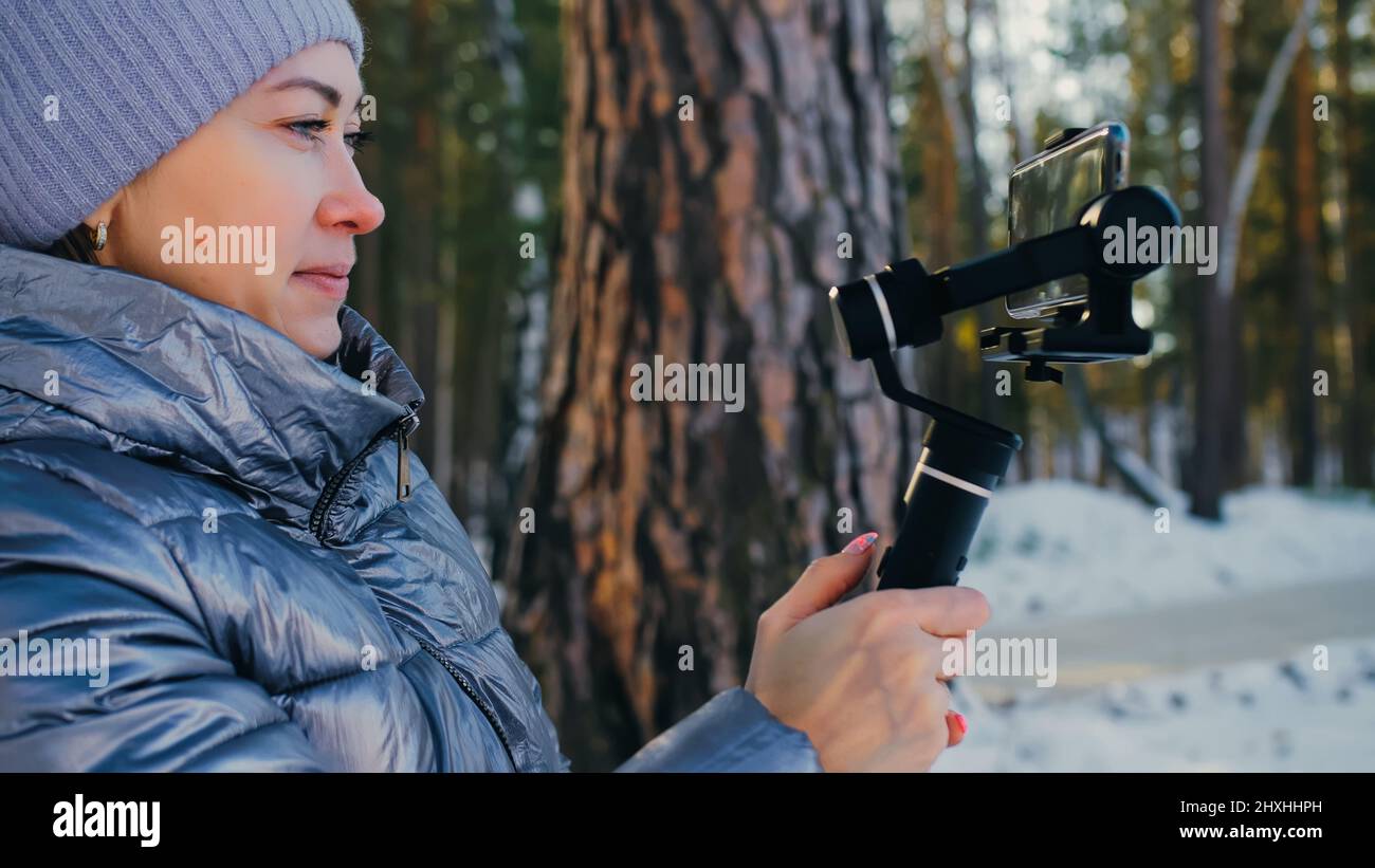 The Woman Professional Videographer Holding Smartphone on 3-axis Gimbal ...