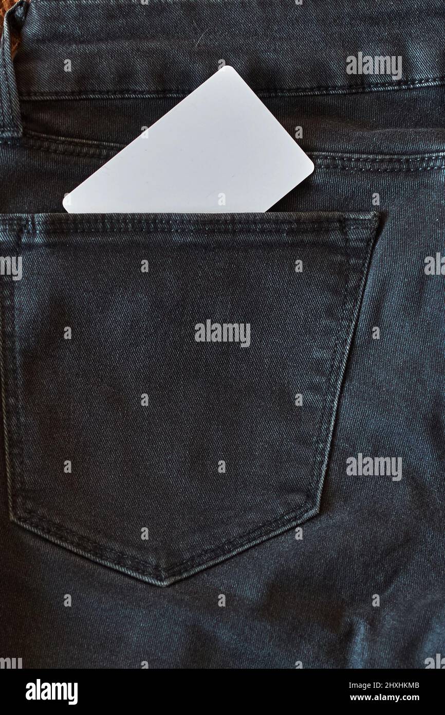 The upper part of old worn black jeans with pockets and a white tag for ...