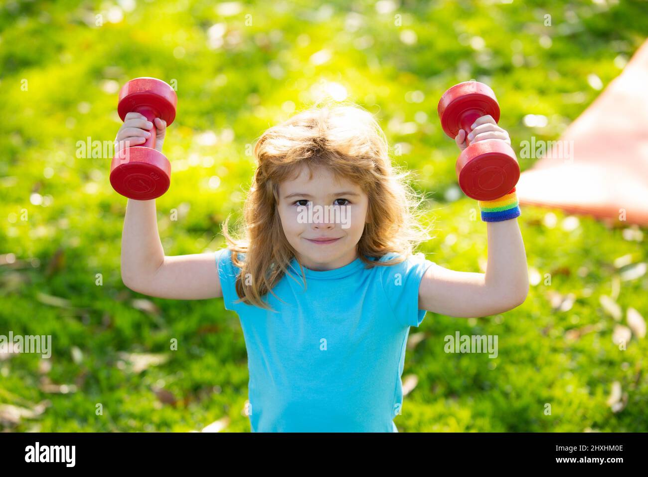 Healthy kids life and sport concept. Portrait of child boy working out ...