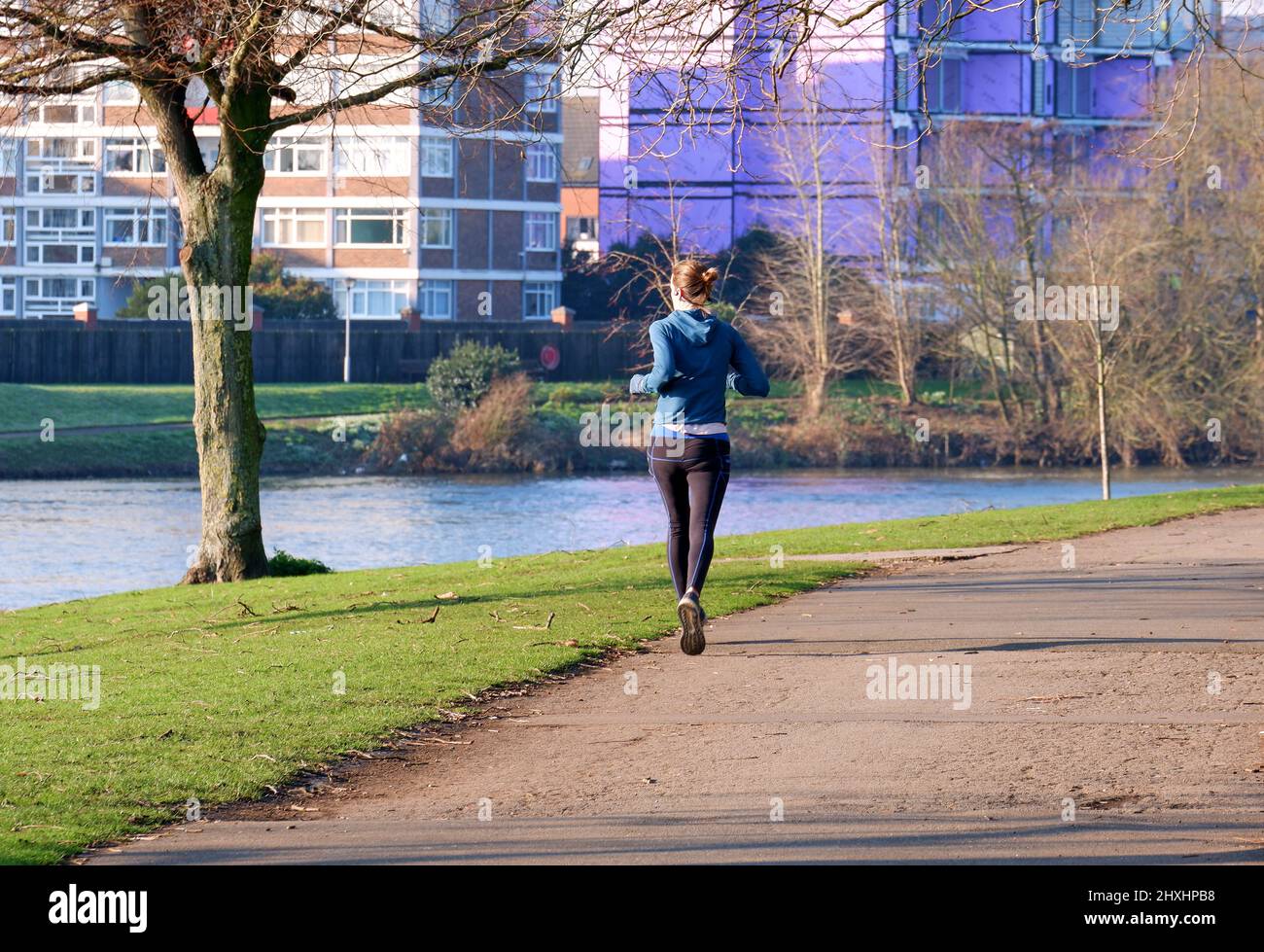 Athletic woman jogging alone Stock Photo - Alamy