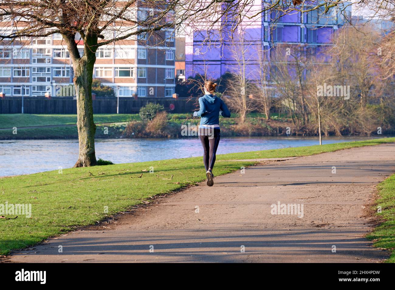 Athletic woman jogging alone Stock Photo - Alamy