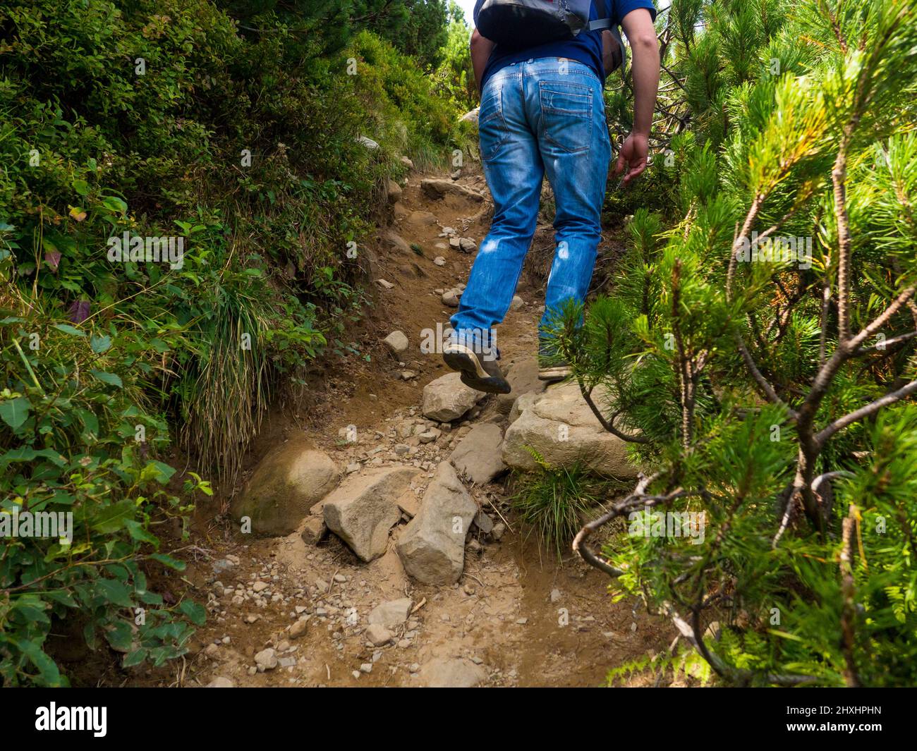 Man climbing grass slope hi-res stock photography and images - Alamy