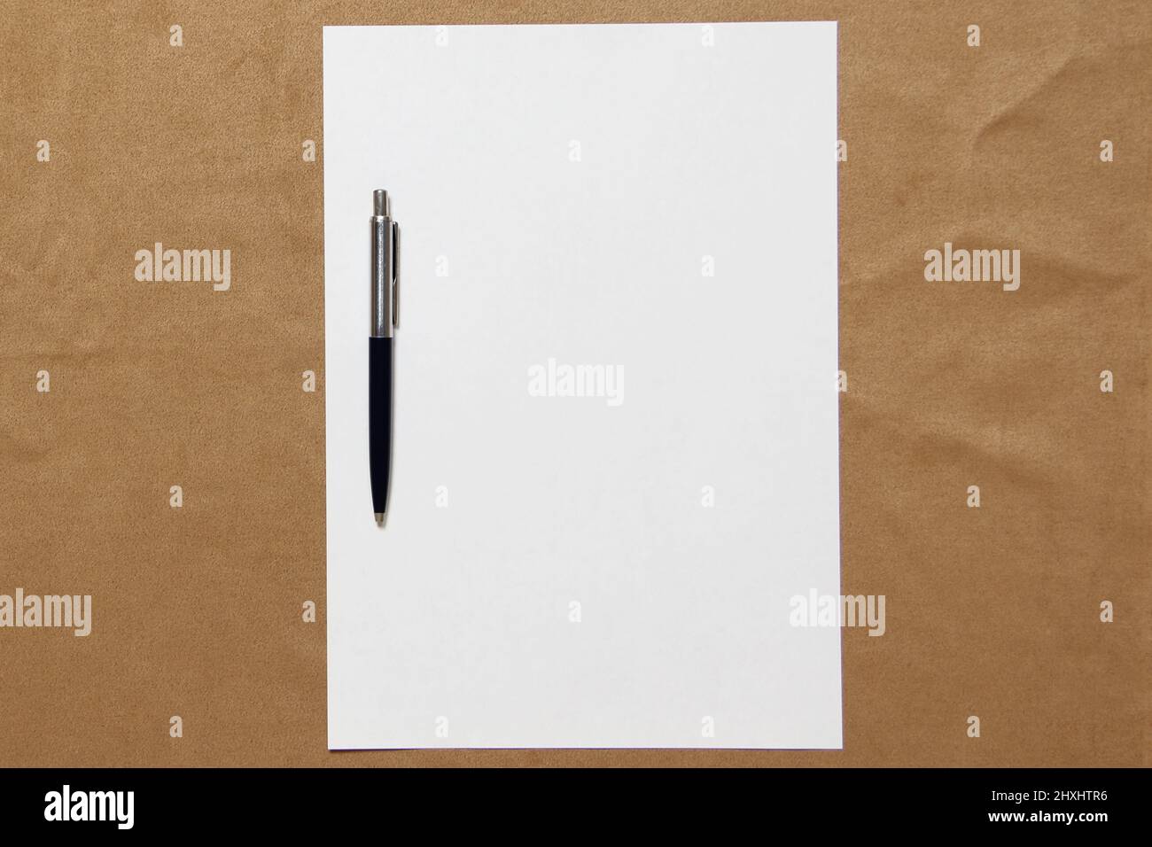 Template of white paper with pen lies on light brown cloth background ...