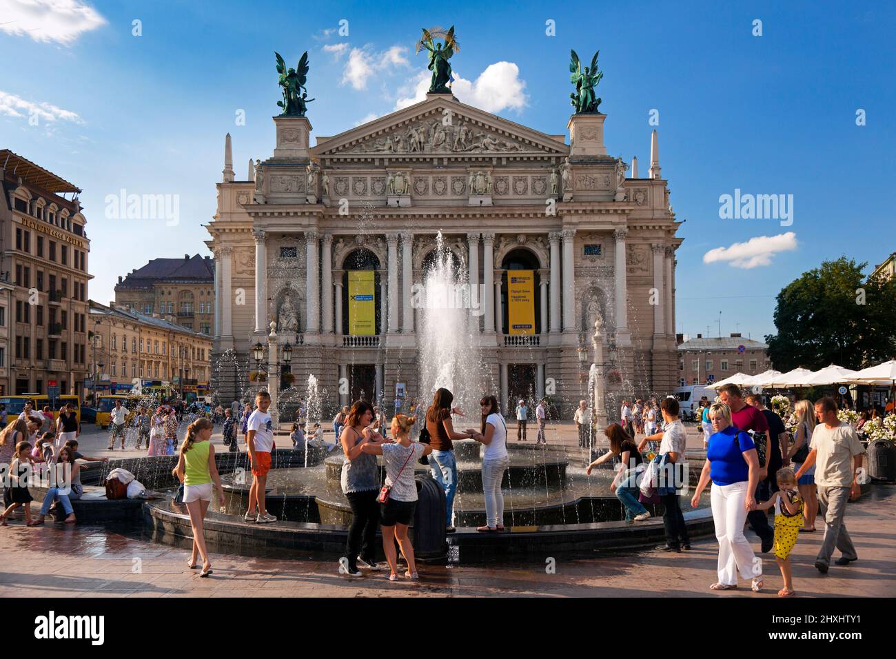 Ukranians and tourists relaxing by the fountain in front of the Opera ...