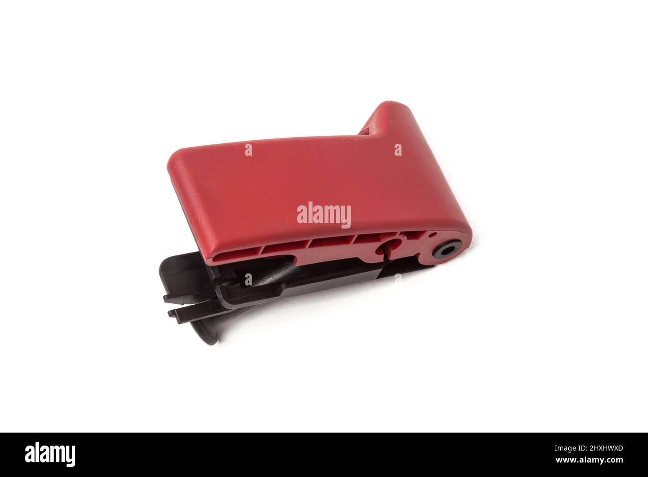 Close-up on a red plastic hood opening handle from a car interior on a ...