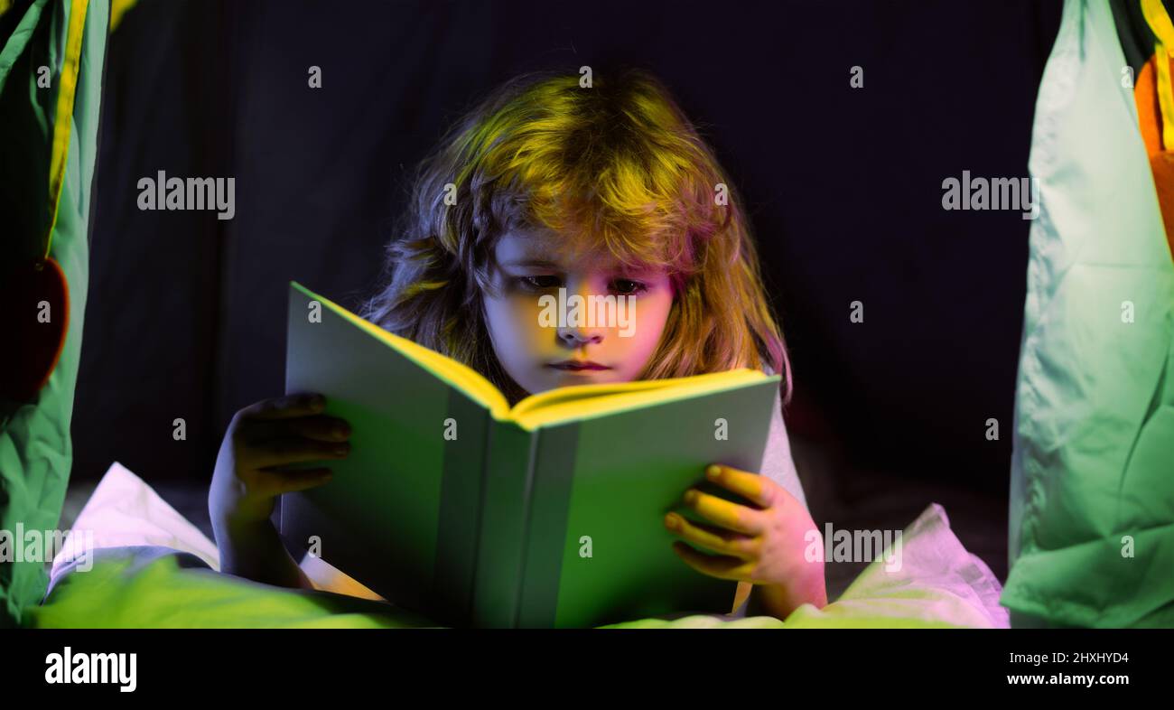 Kids bedtime. Boy read book in bed Stock Photo - Alamy