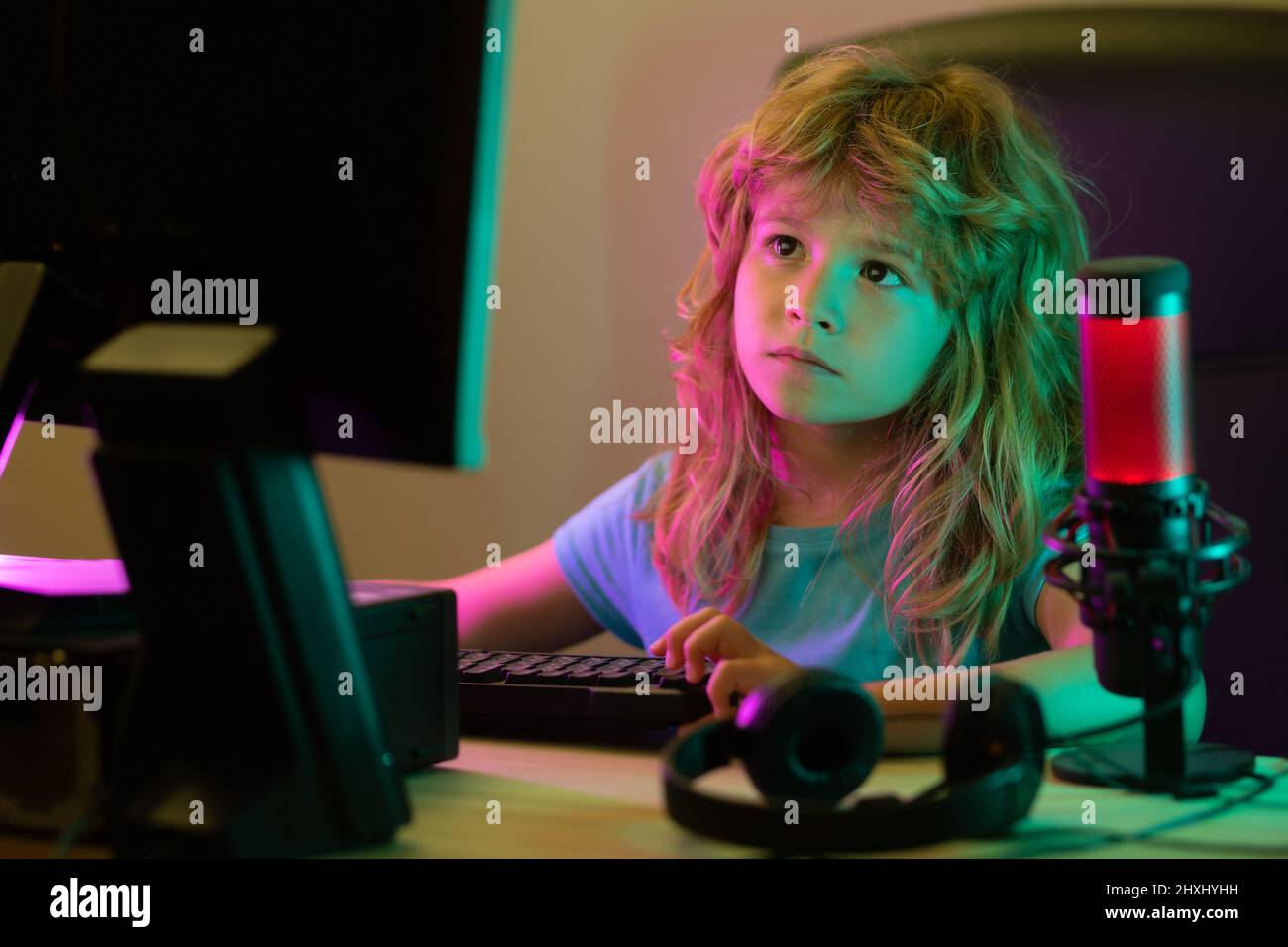 Child learning in virtual online school class. Kid working on laptop ...