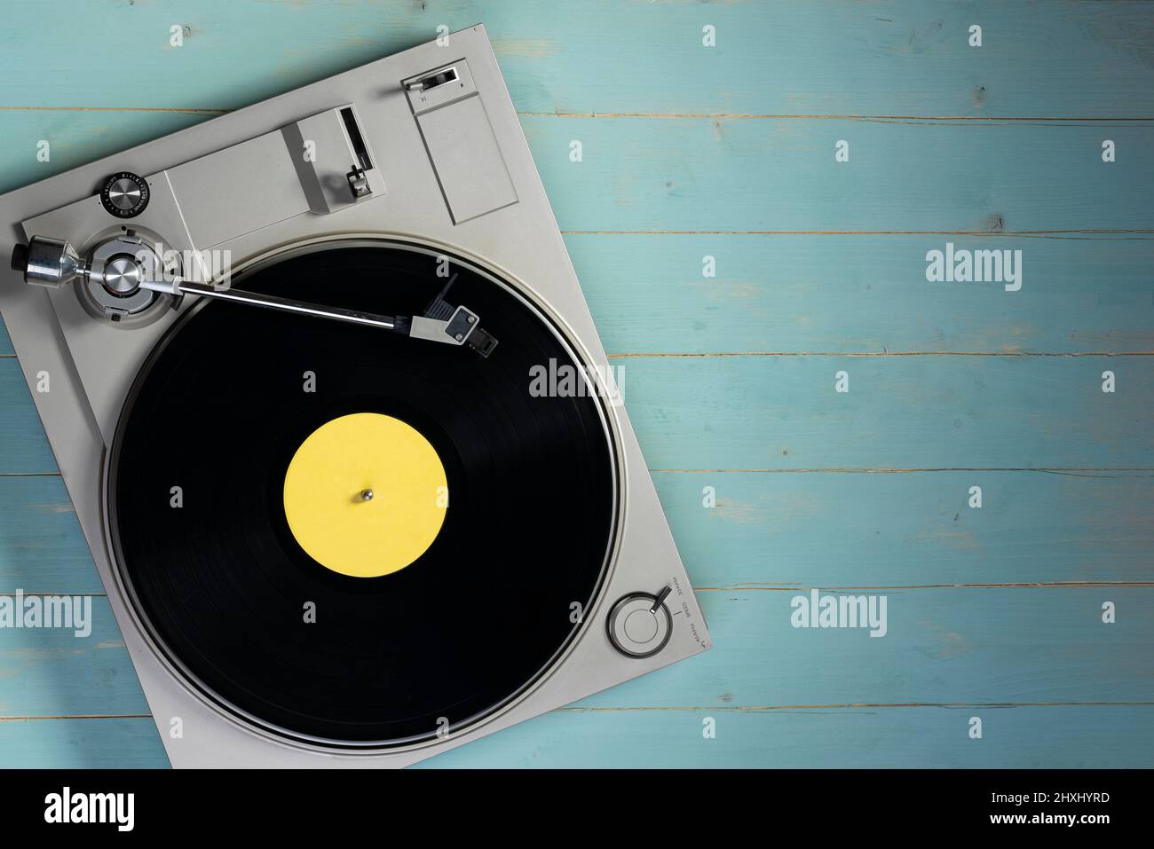 Gramophone with a vinyl record on rustic wooden table, top view and ...