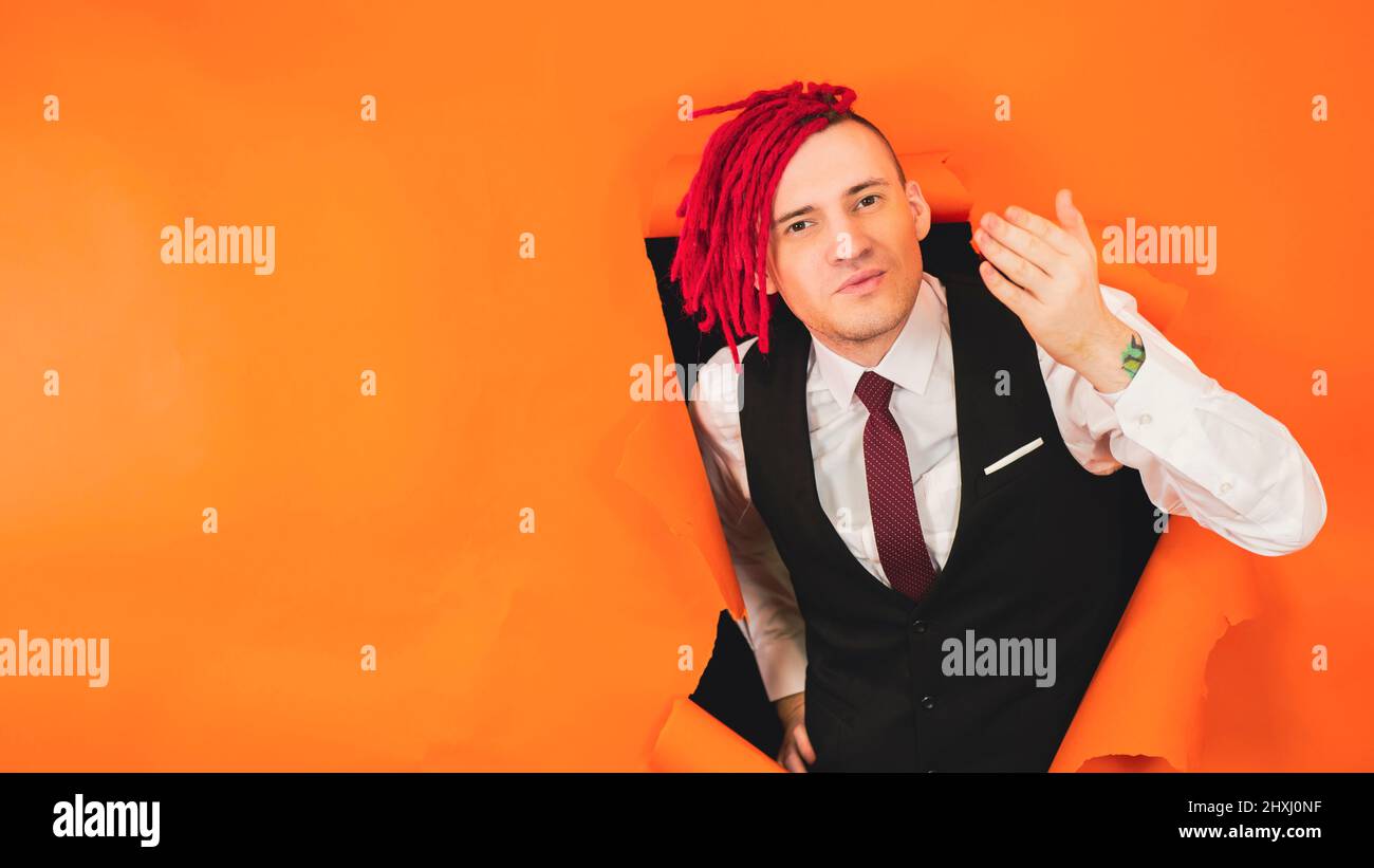 Smiling man with red dreadlocks sending blowing kiss. Portrait pretty ...