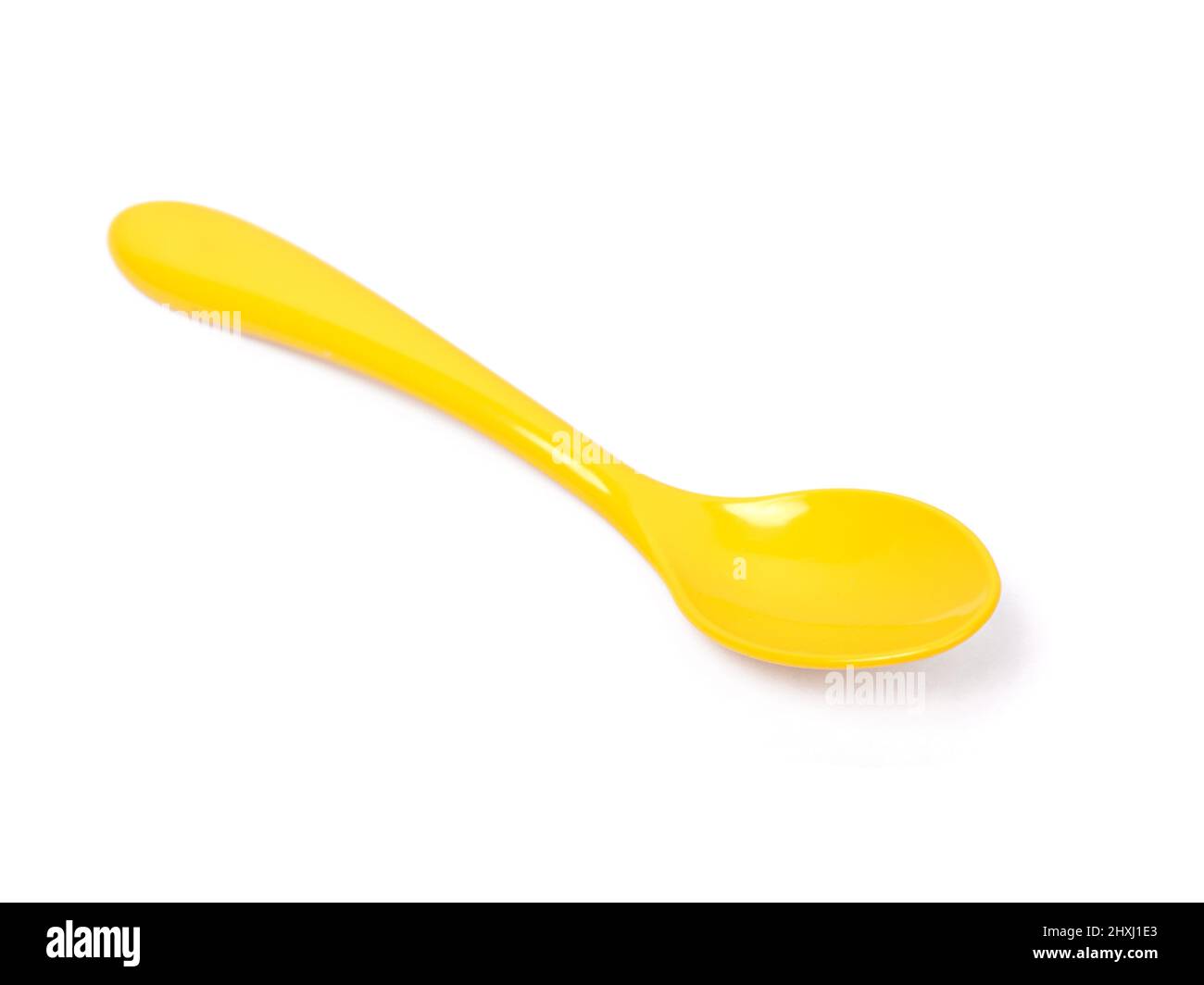 Single yellow plastic spoon isolated on white background Stock Photo ...