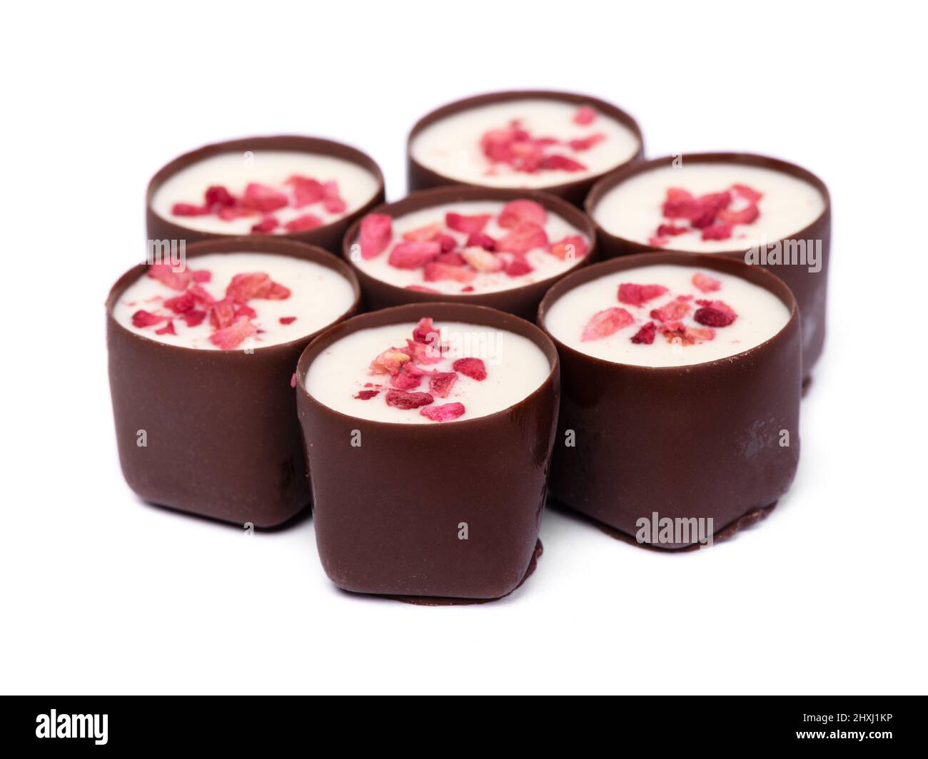 Heap of chocolate glazed sweets with fruit pieces isolated on white ...