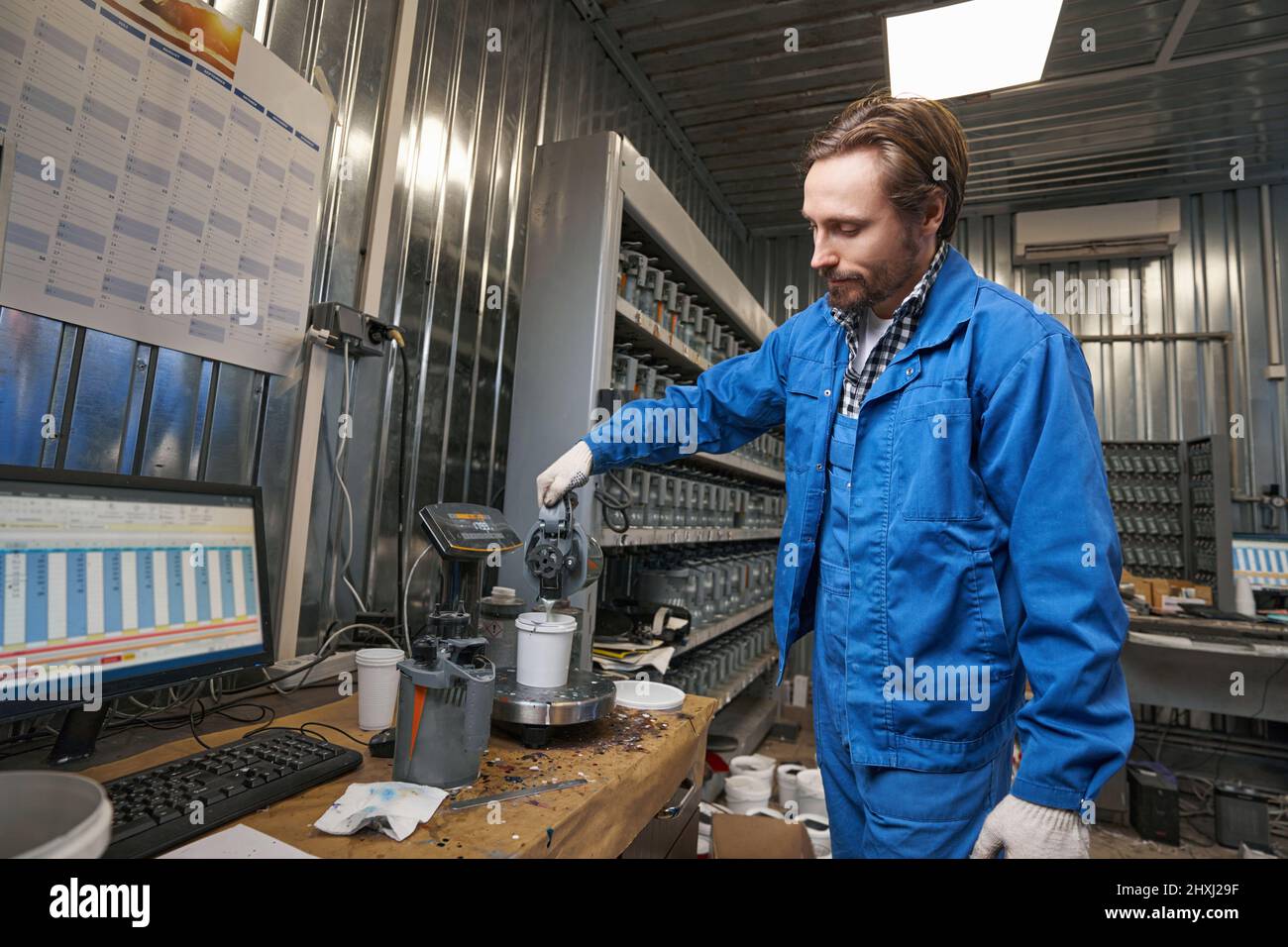 Working process of male in paint shop Stock Photo - Alamy