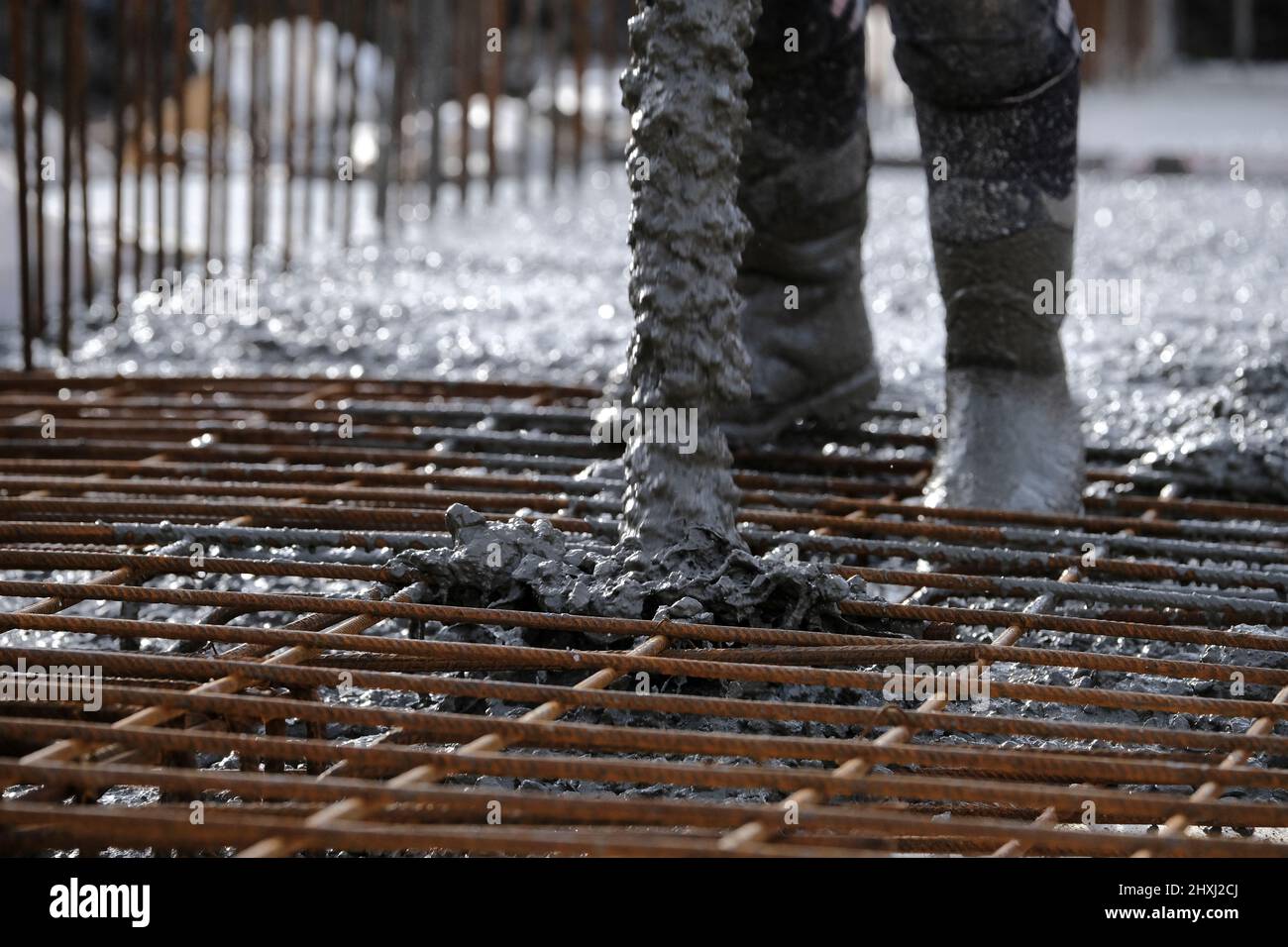 Workmen onsite at house construction, pouring base concrete layer from ...