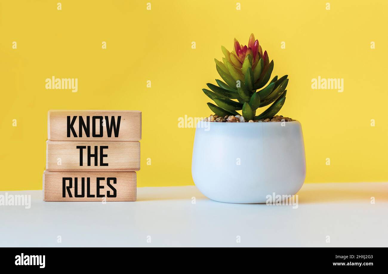 Know the rules word on wooden blocks, on a white and yellow background ...