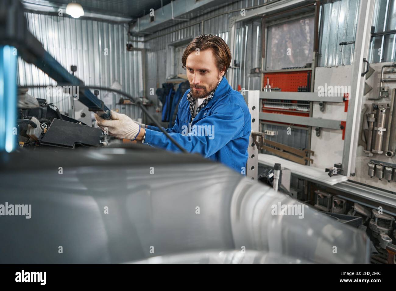 Mechanic holding special tool for auto repair Stock Photo - Alamy