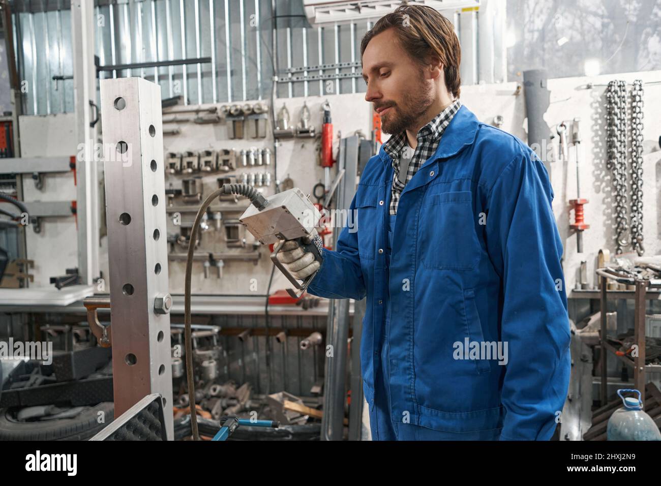 Professional man holding special tool for auto repair Stock Photo - Alamy