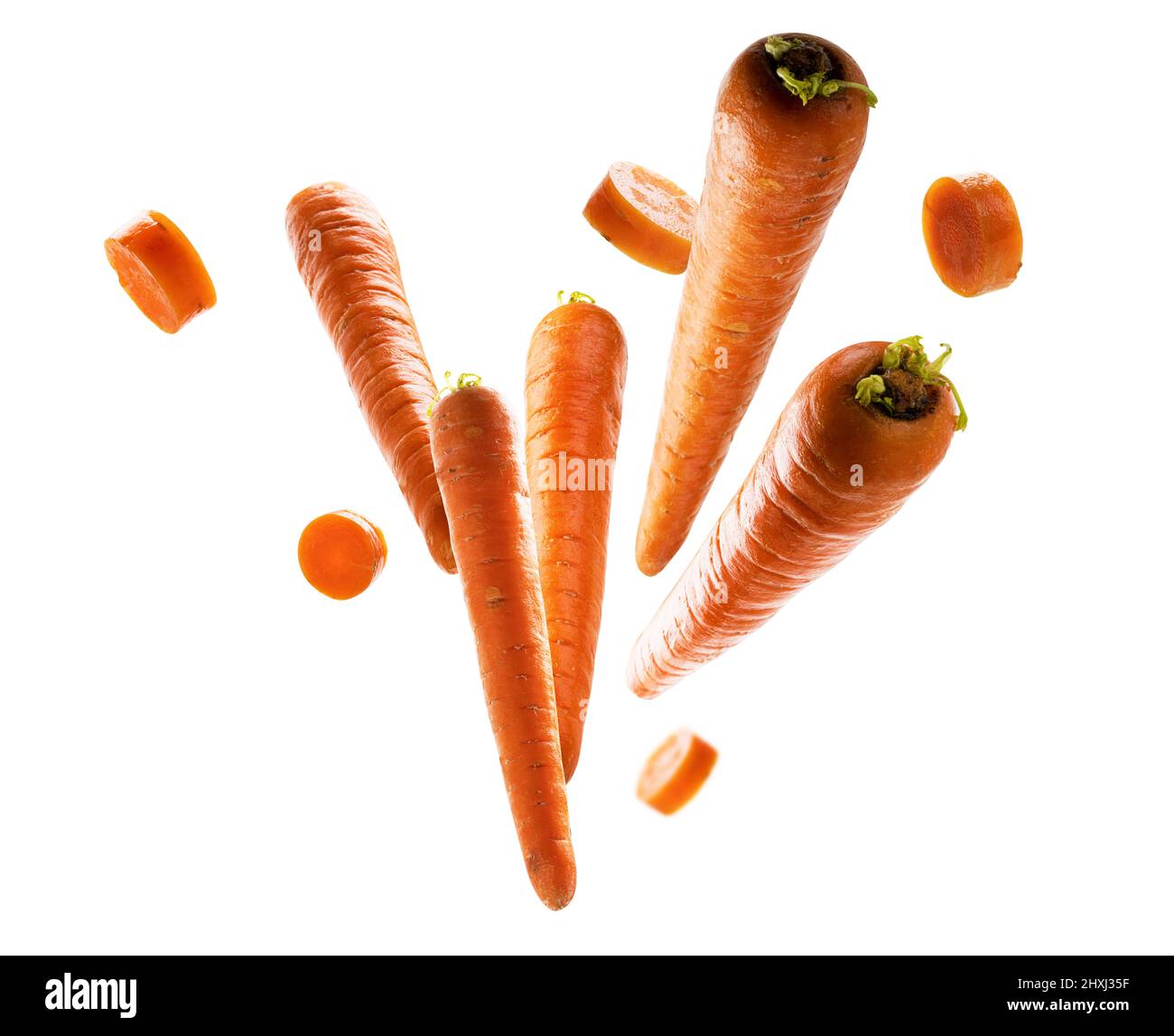 Ripe carrots whole and sliced levitate on a white background Stock ...