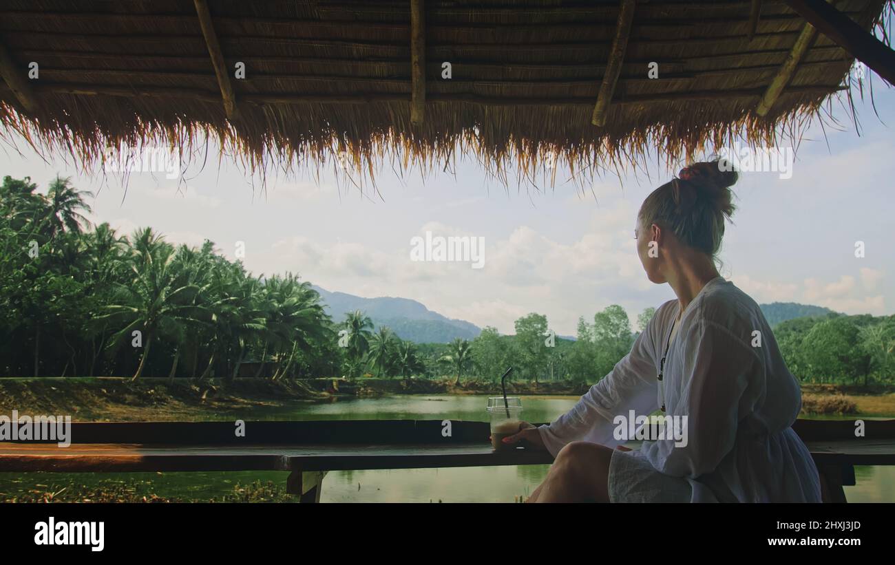 Woman drinking cocktail tasty beverages, iced coffee. Traveler spending ...