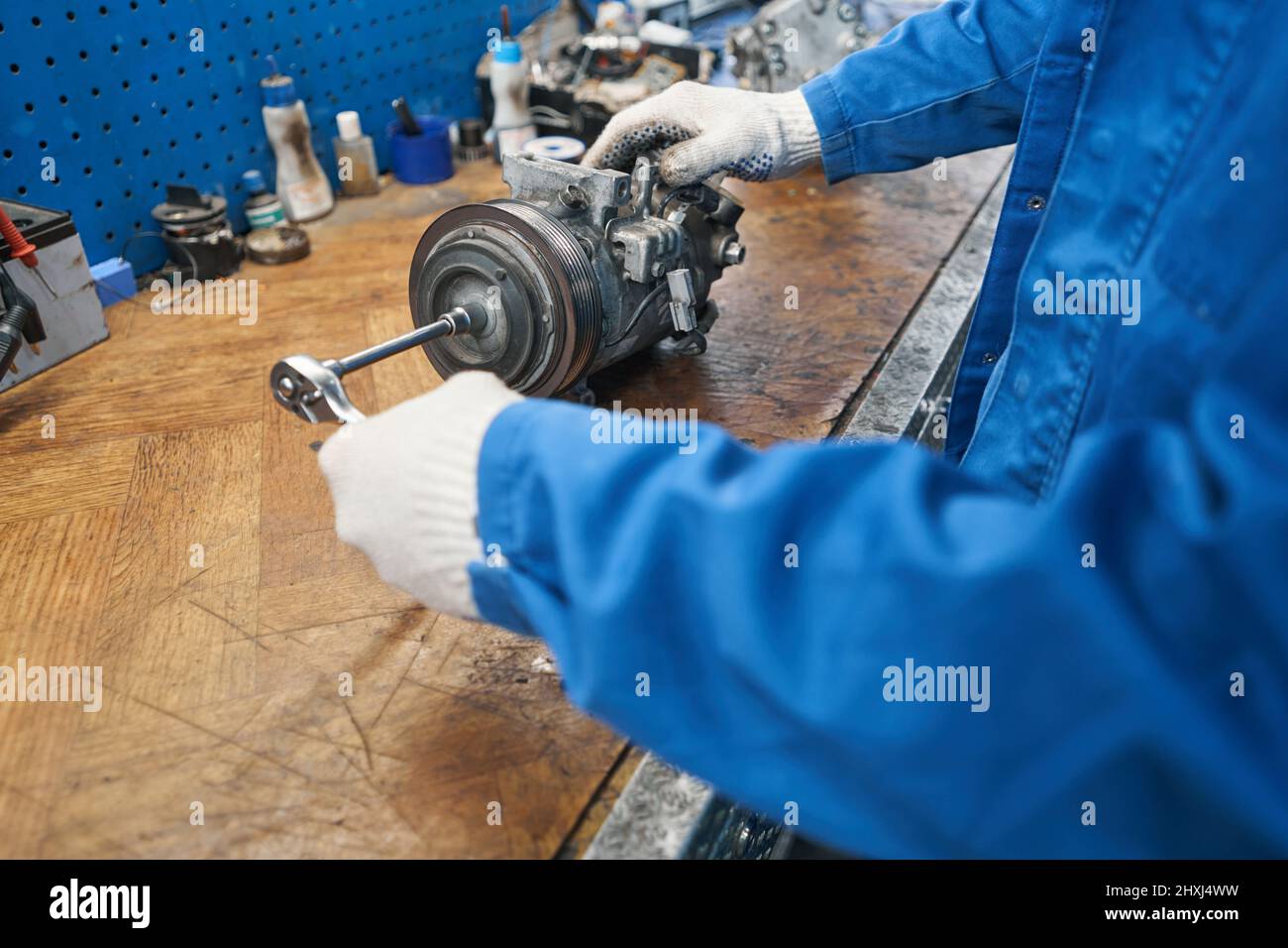 Close-up photo of mechanic holding tool and car conditioner Stock Photo ...