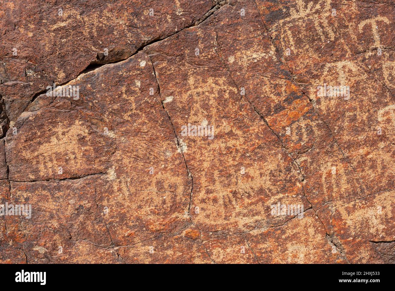 A rock bearing 26 petroglyphs across four faces in Wadi Saham in the ...
