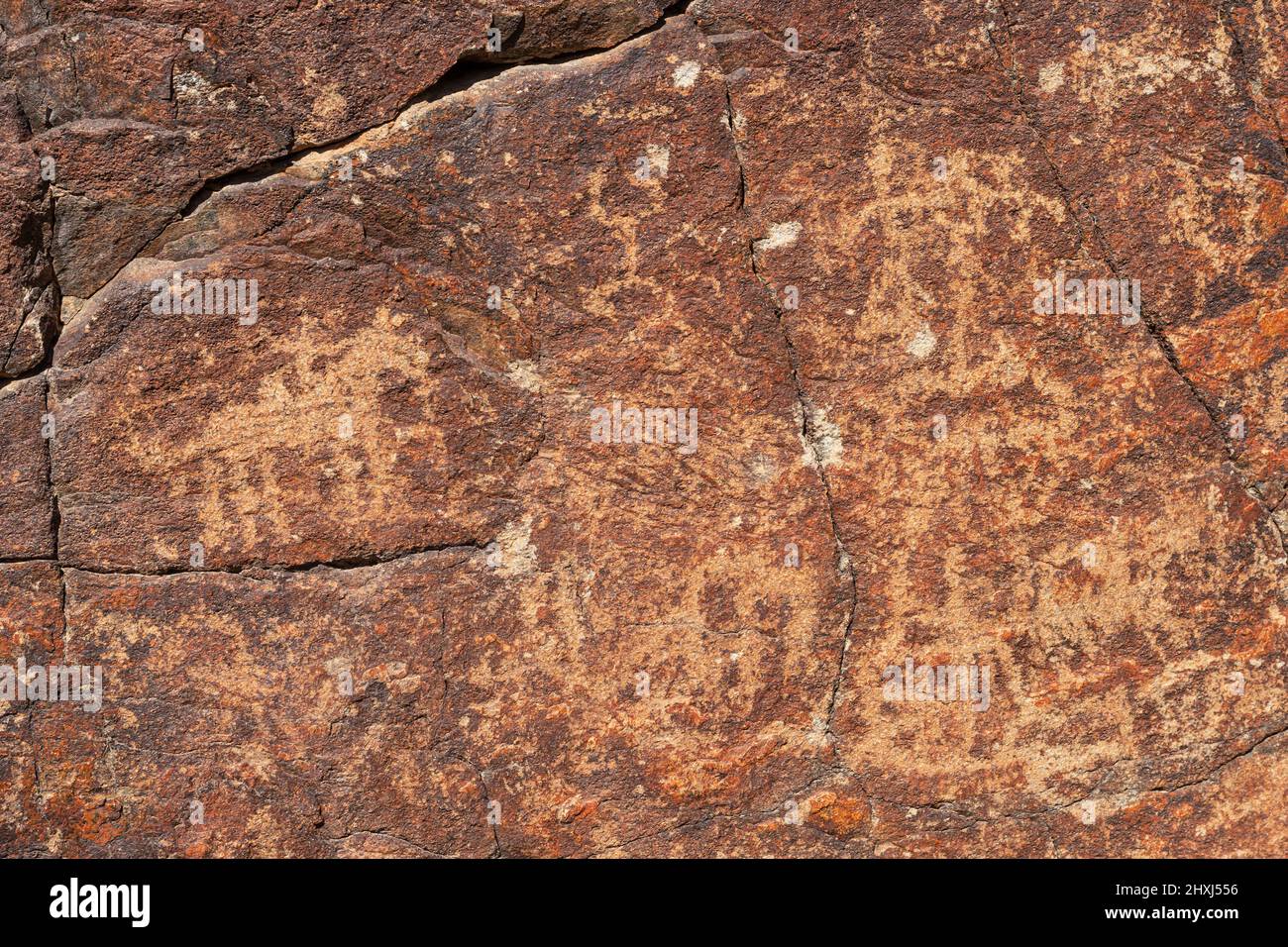 A rock bearing 26 petroglyphs across four faces in Wadi Saham in the ...