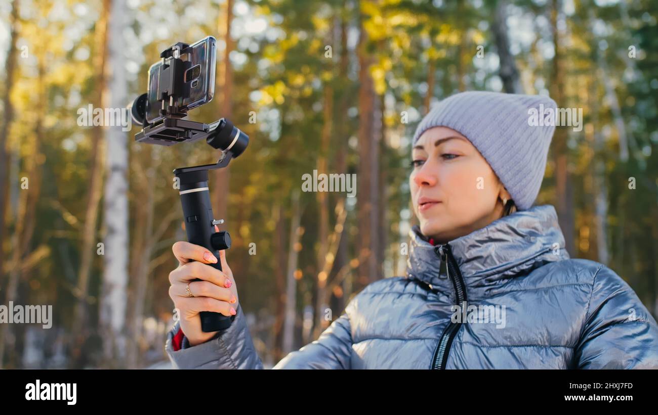 The Woman Professional Videographer Holding Smartphone on 3-axis Gimbal ...