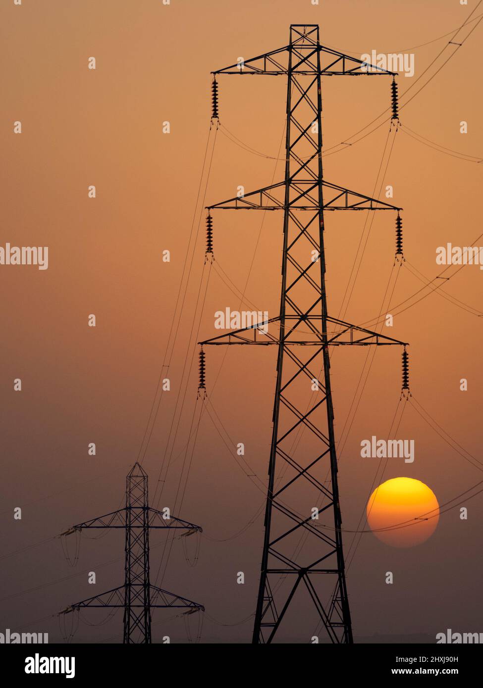 Electricity pylons in Lower Radley Village, winter sunrise 1 Stock ...