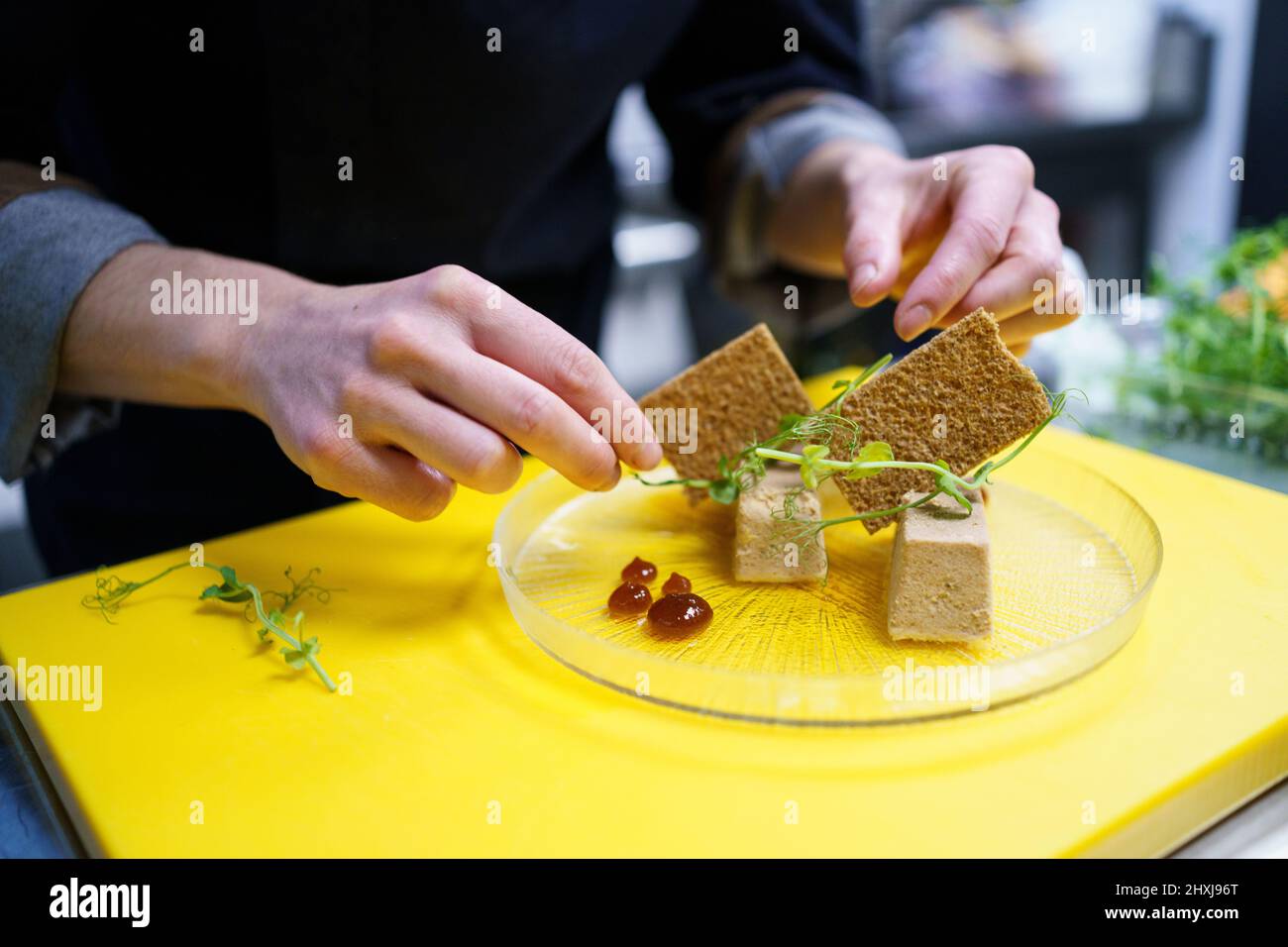 Crop chef plating foie micuit with crunchy croutons in restaurant Stock ...