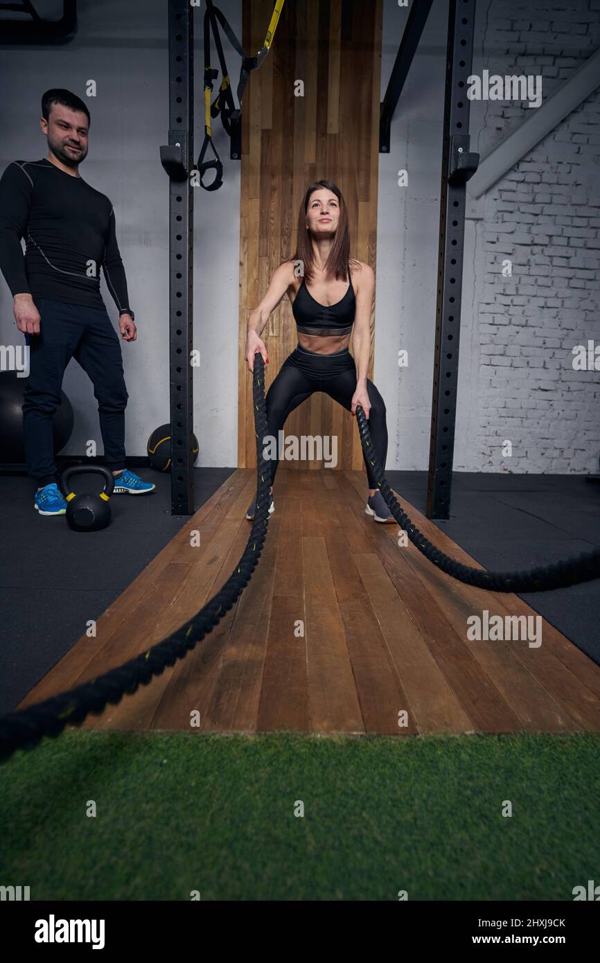 Woman doing battle rope workout hi-res stock photography and images - Alamy