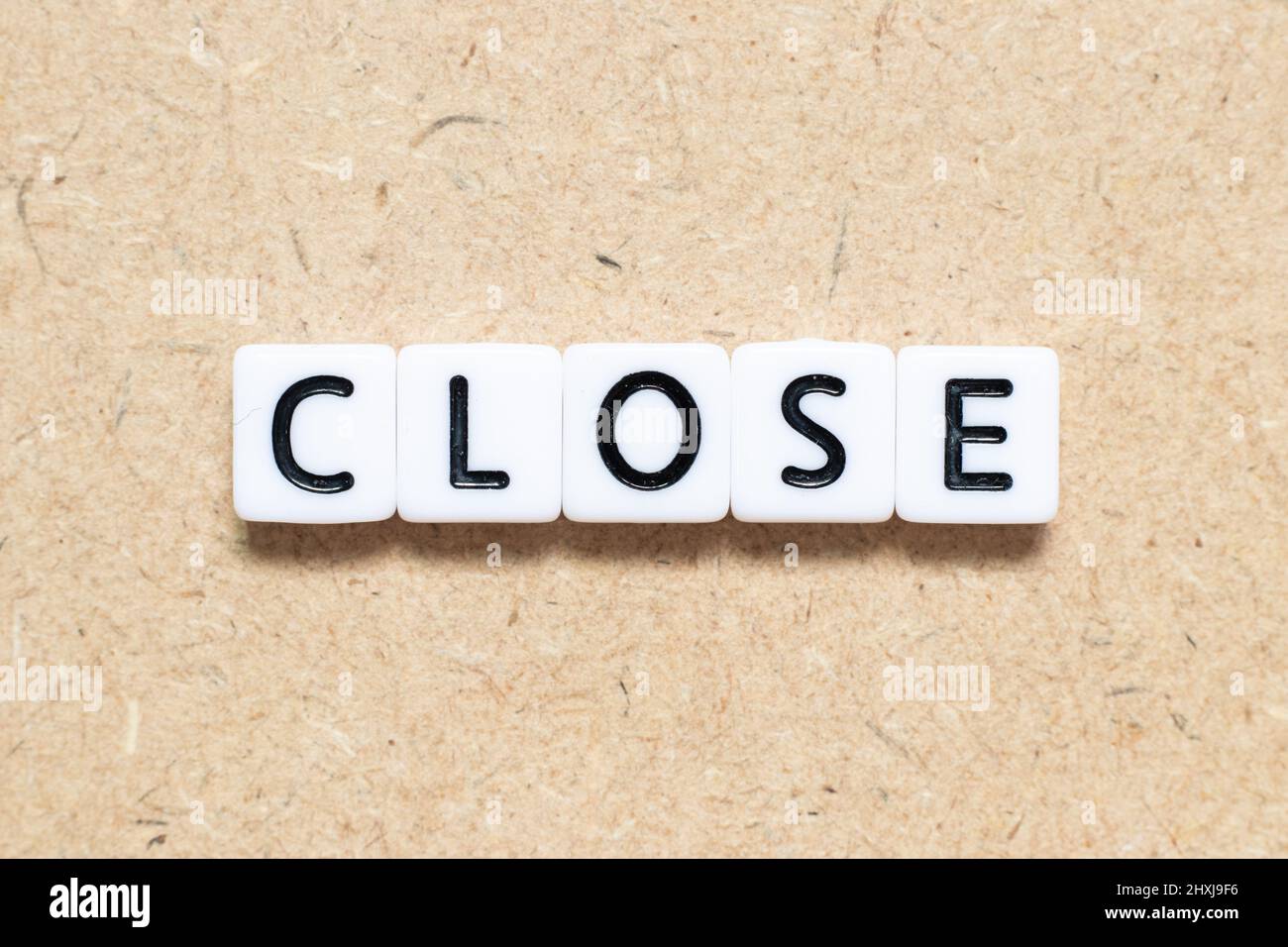 White tile alphabet letter with word close on wood background Stock ...