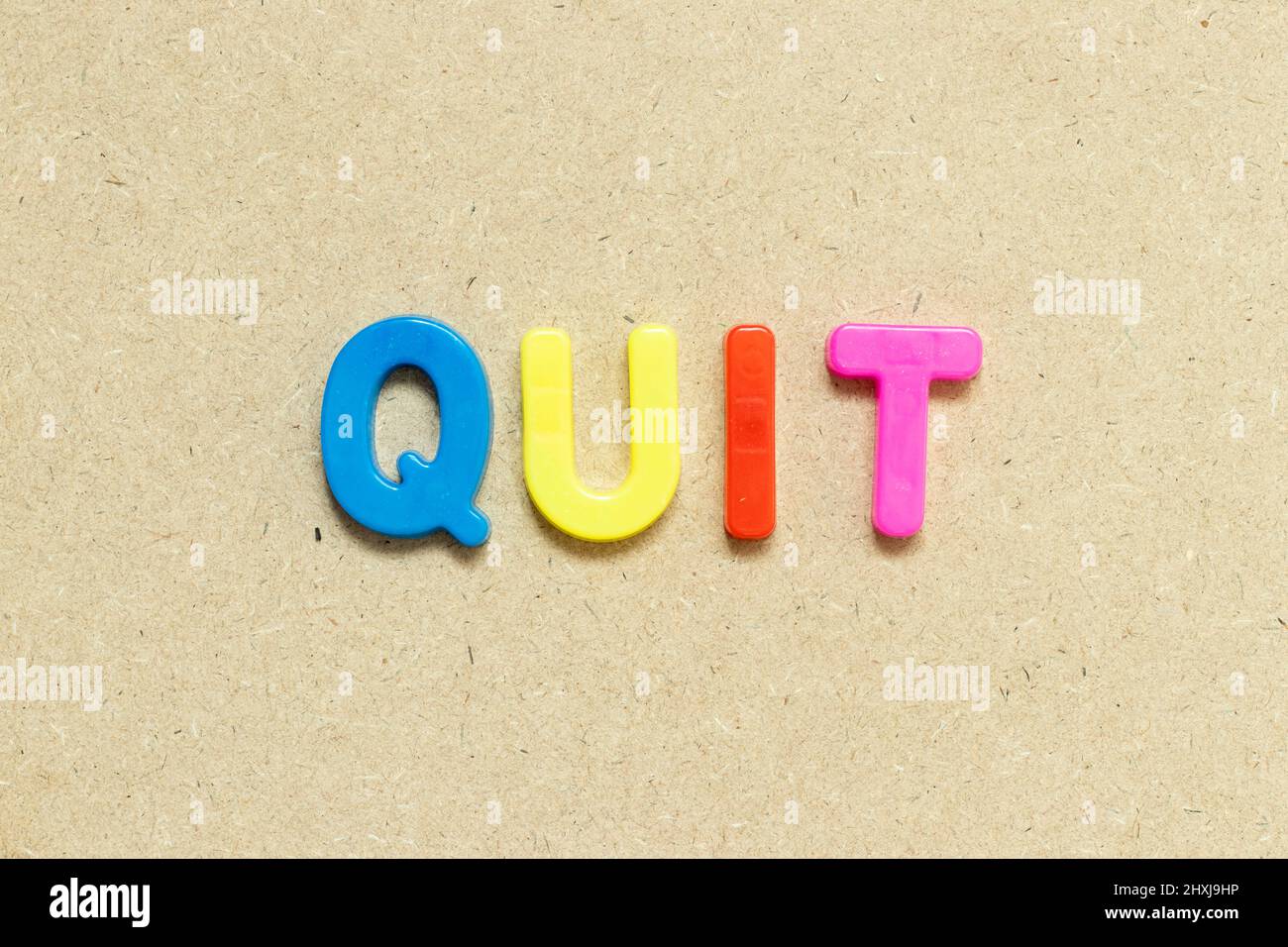 Color alphabet letter with word quit on wood background Stock Photo - Alamy