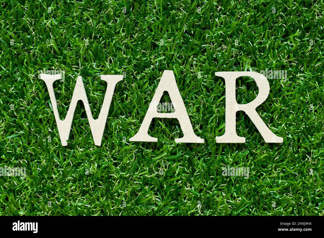 Wood alphabet letter in word war on green grass background Stock Photo ...