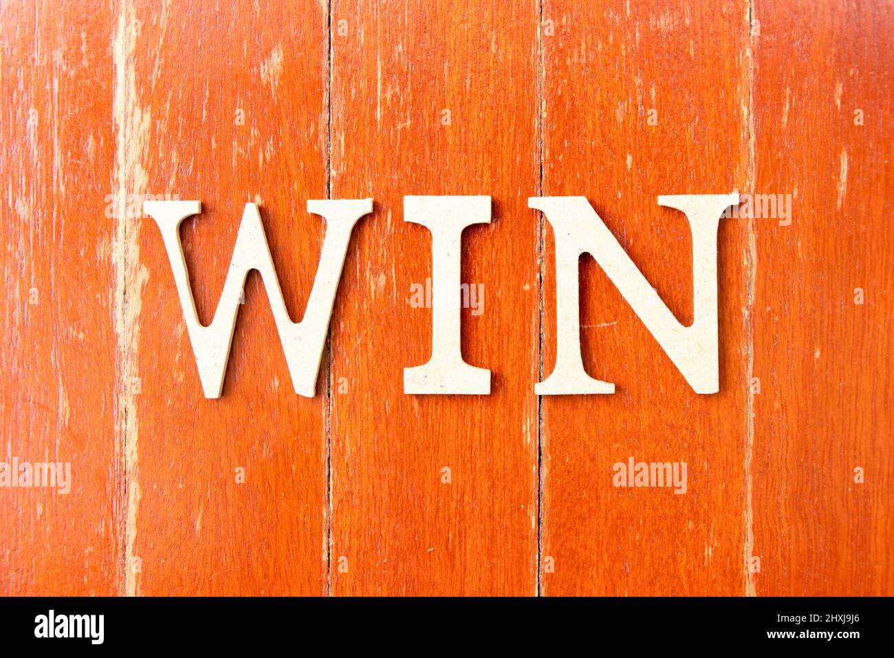 Alphabet letter in word win on old red color wood plate background ...