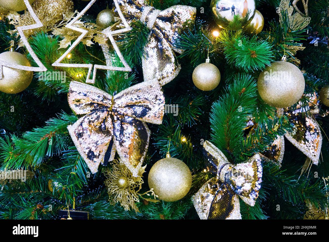 A section of a New Year's Christmas tree with toys and illumination on ...