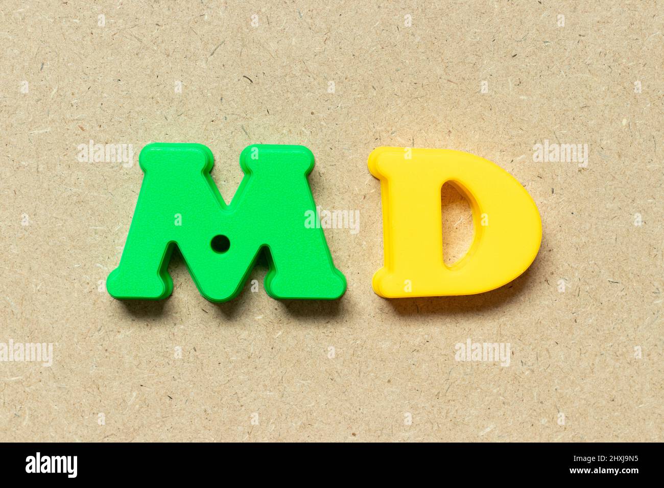 Plastic alphabet letter in word MD (abbreviation of doctor of medicine ...