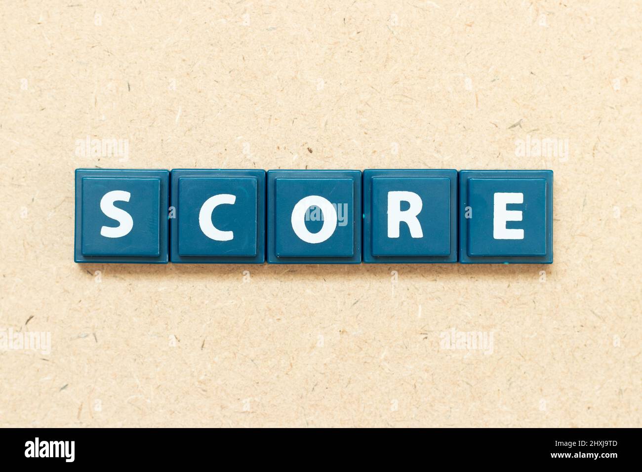 Tile alphabet letter in word score on wood background Stock Photo - Alamy