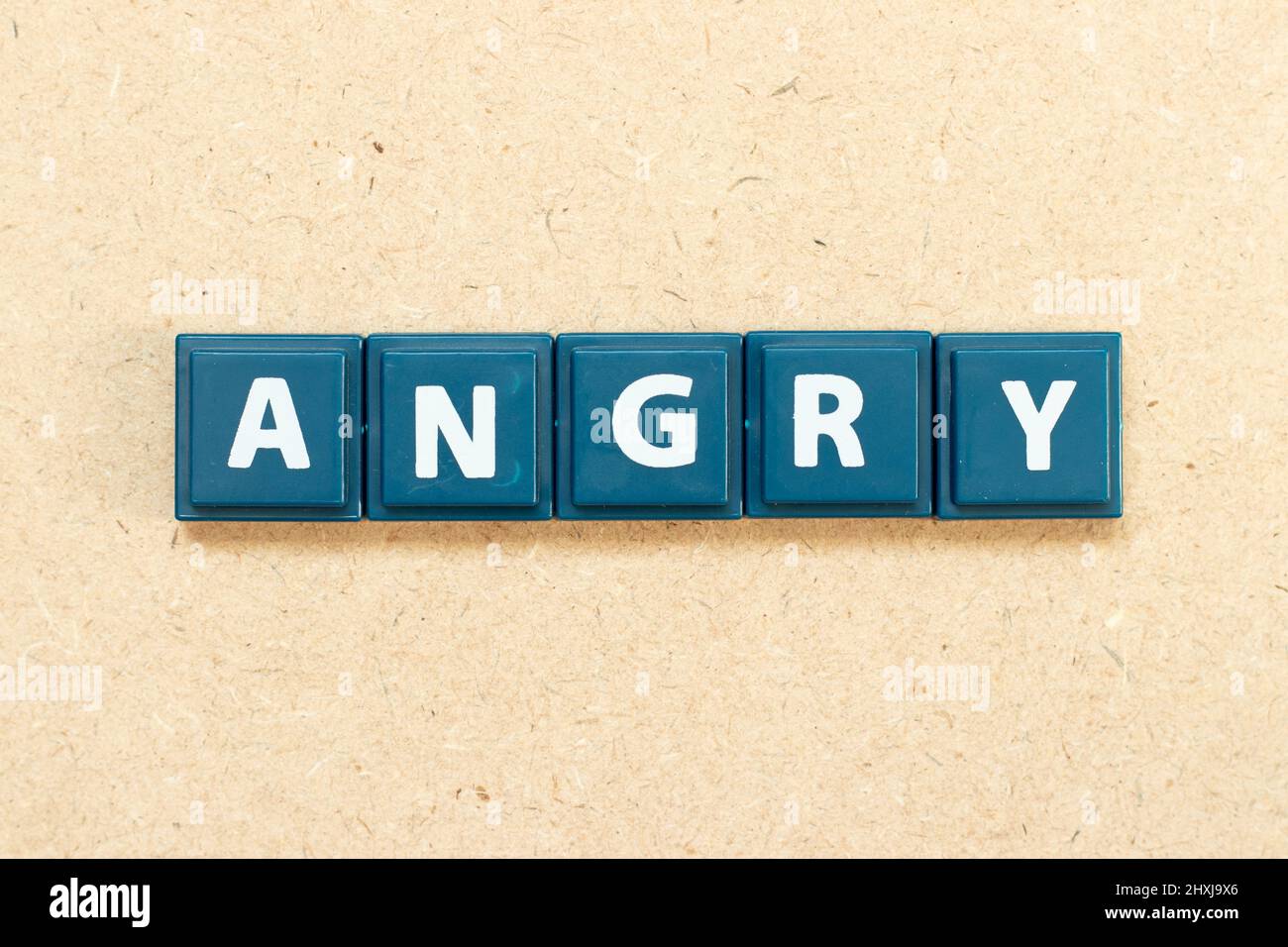 Tile alphabet letter in word angry on wood background Stock Photo - Alamy